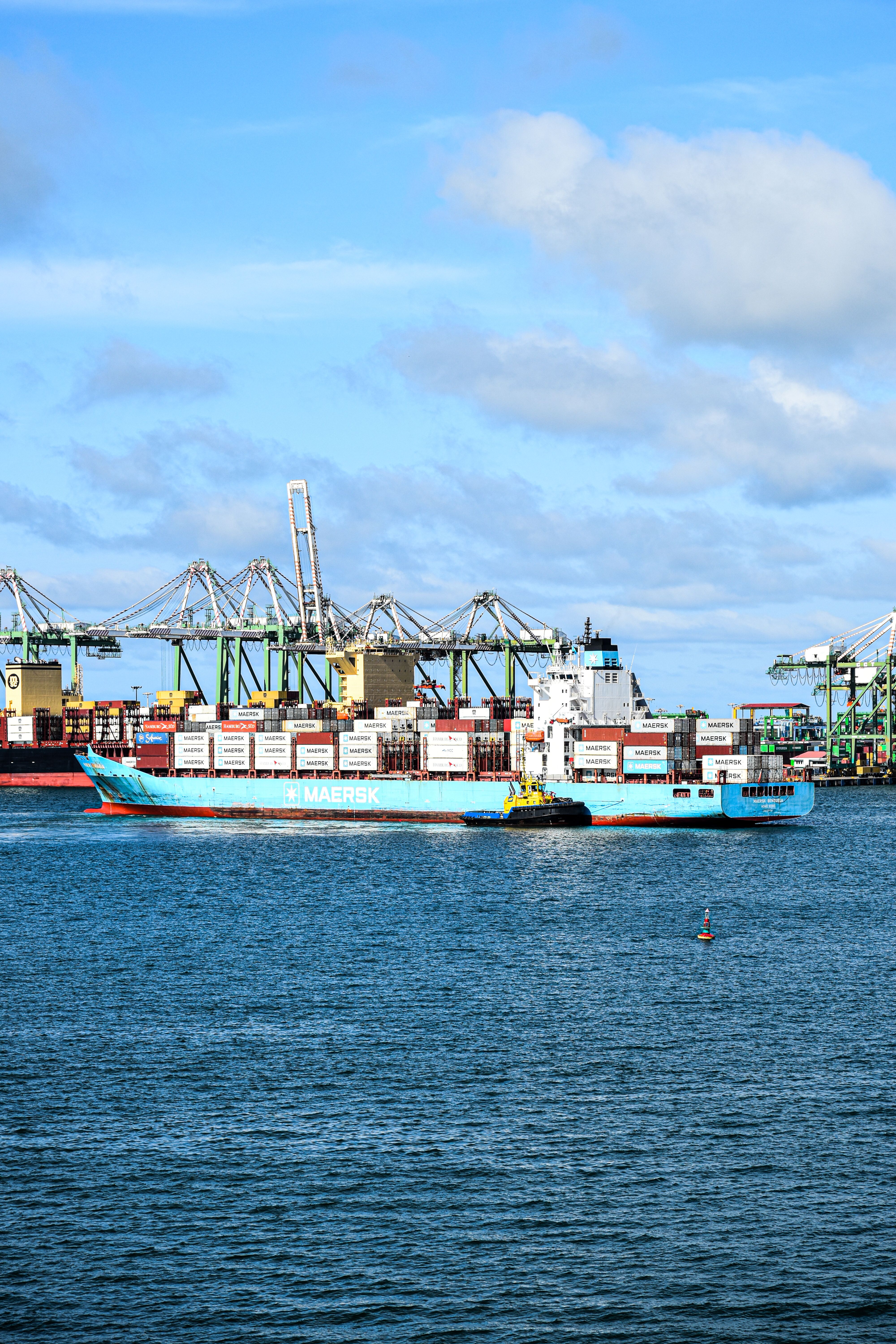 Cargo Ship in Port with Cranes Under Blue Sky · Free Stock Photo