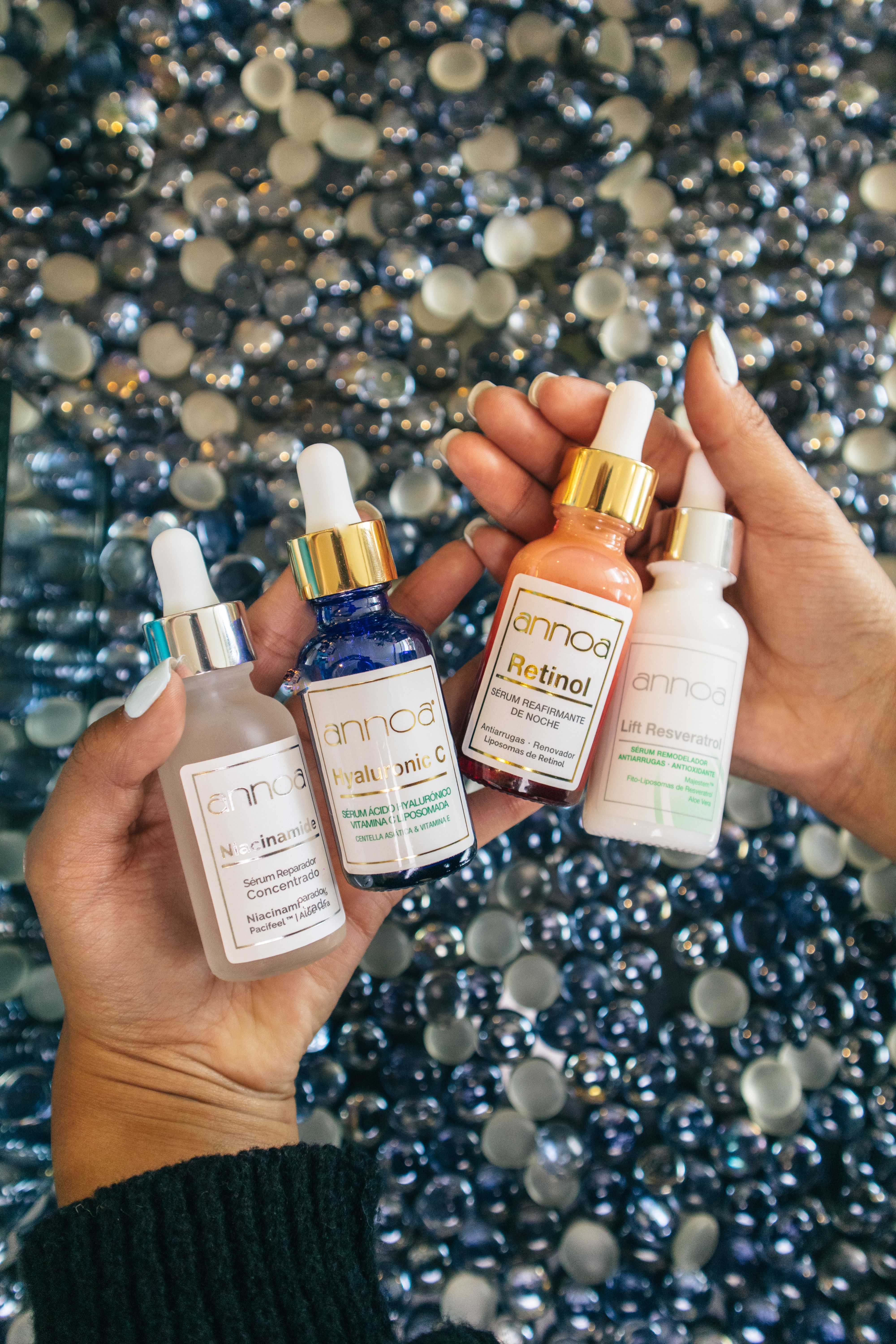 Assorted Skincare Serums in Hands · Free Stock Photo