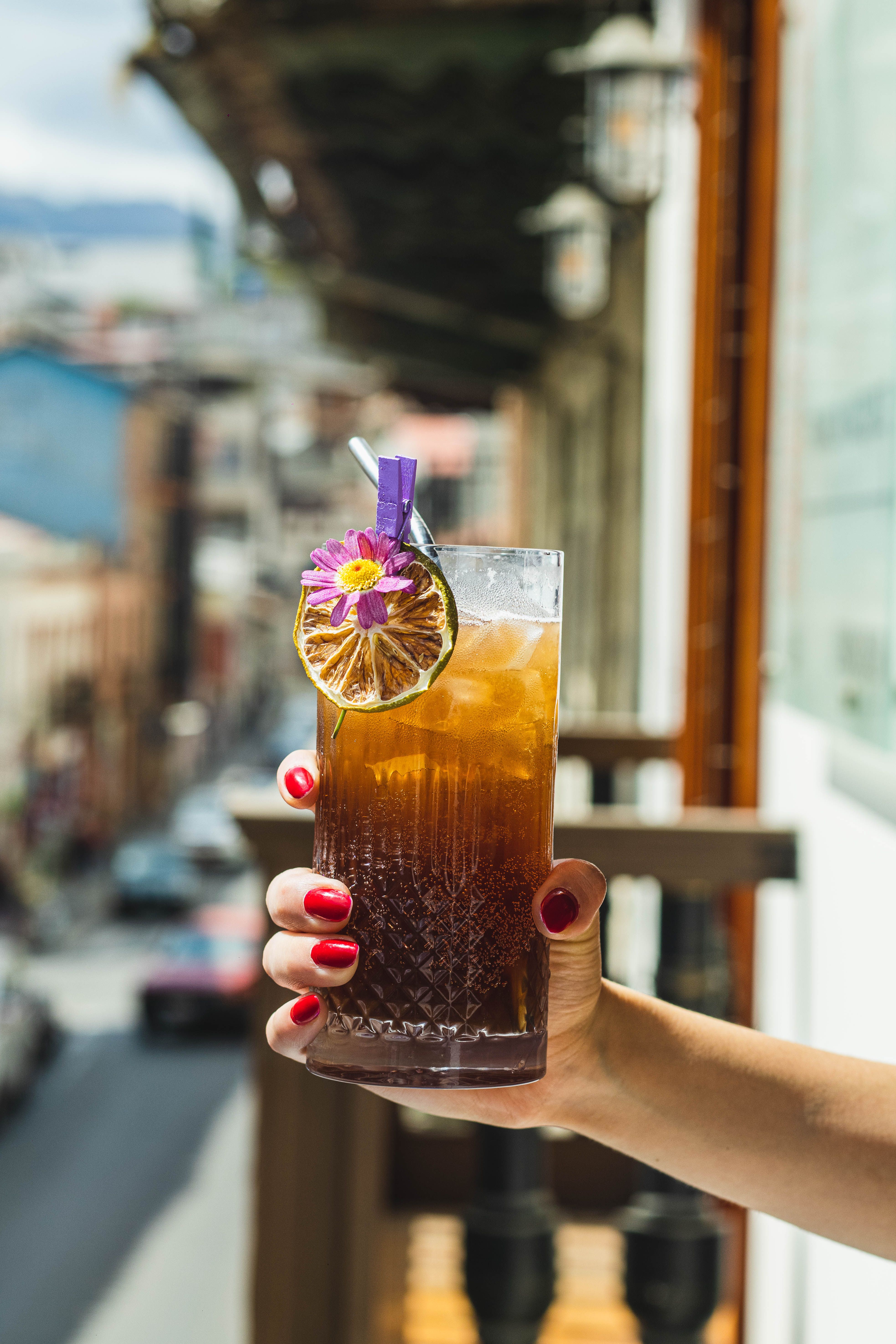 Refreshing Iced Drink with Lime and Flower Garnish · Free Stock Photo
