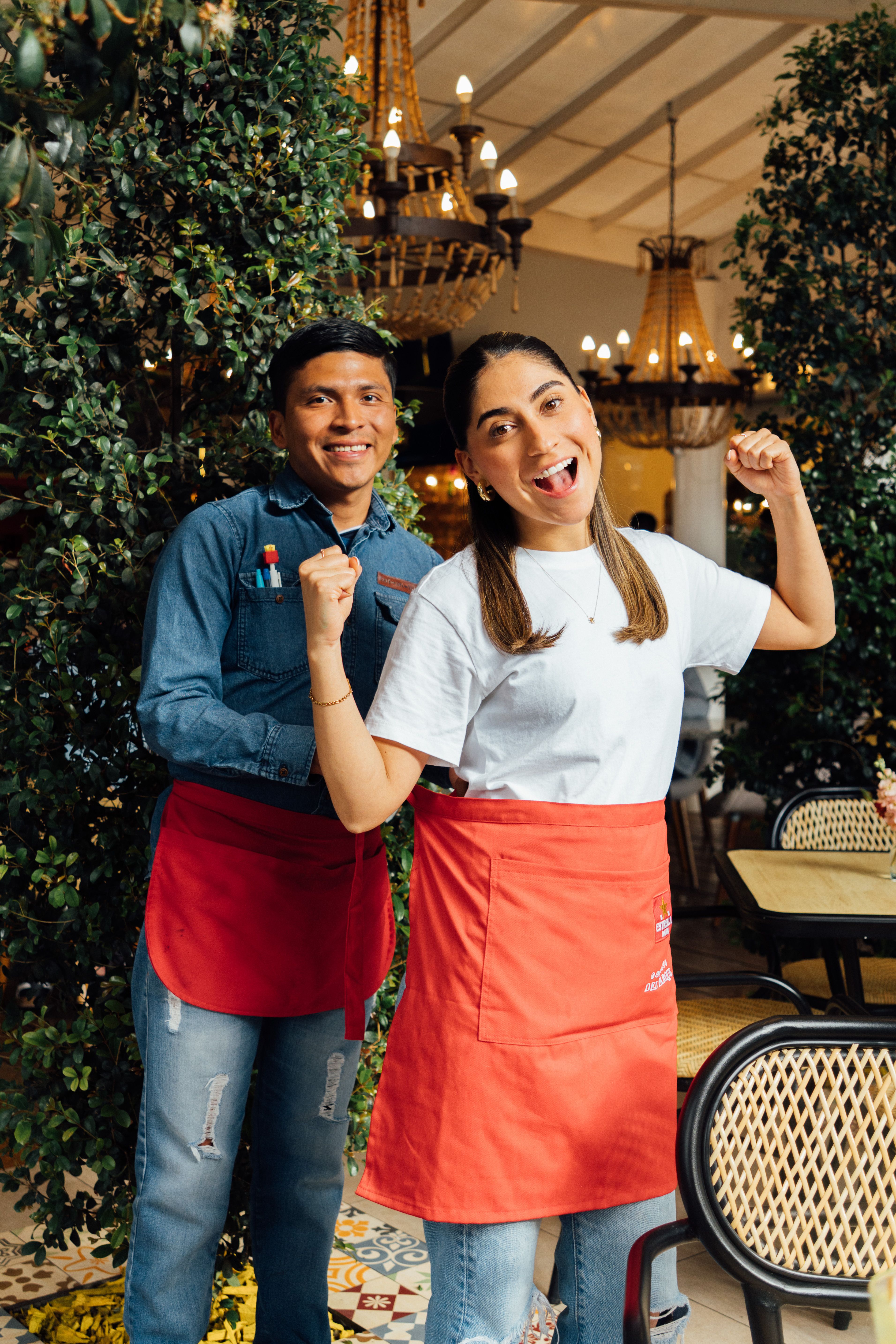Cheerful Restaurant Staff in Red Aprons Smiling · Free Stock Photo