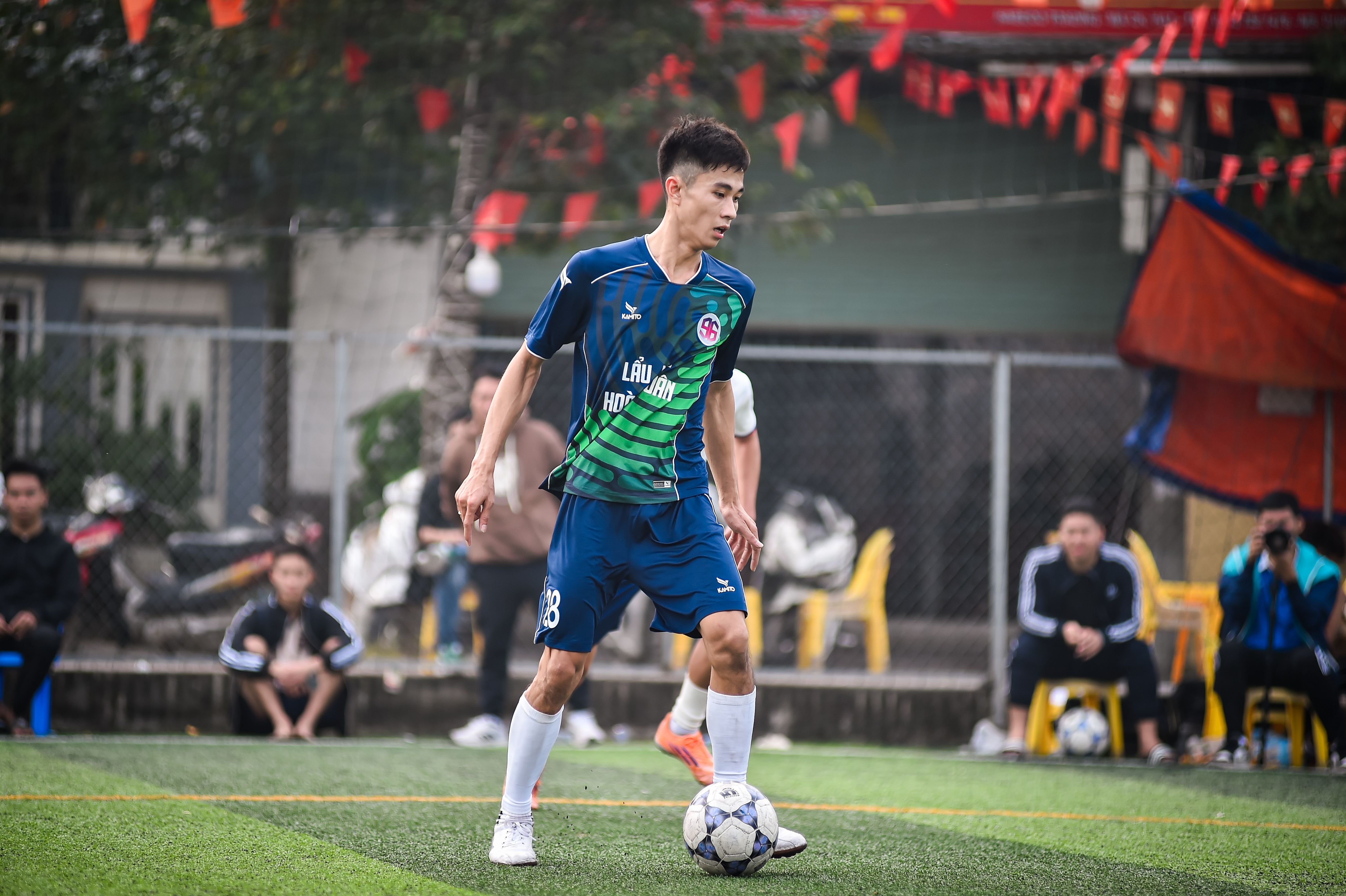 Young Footballer in Action on Outdoor Field · Free Stock Photo