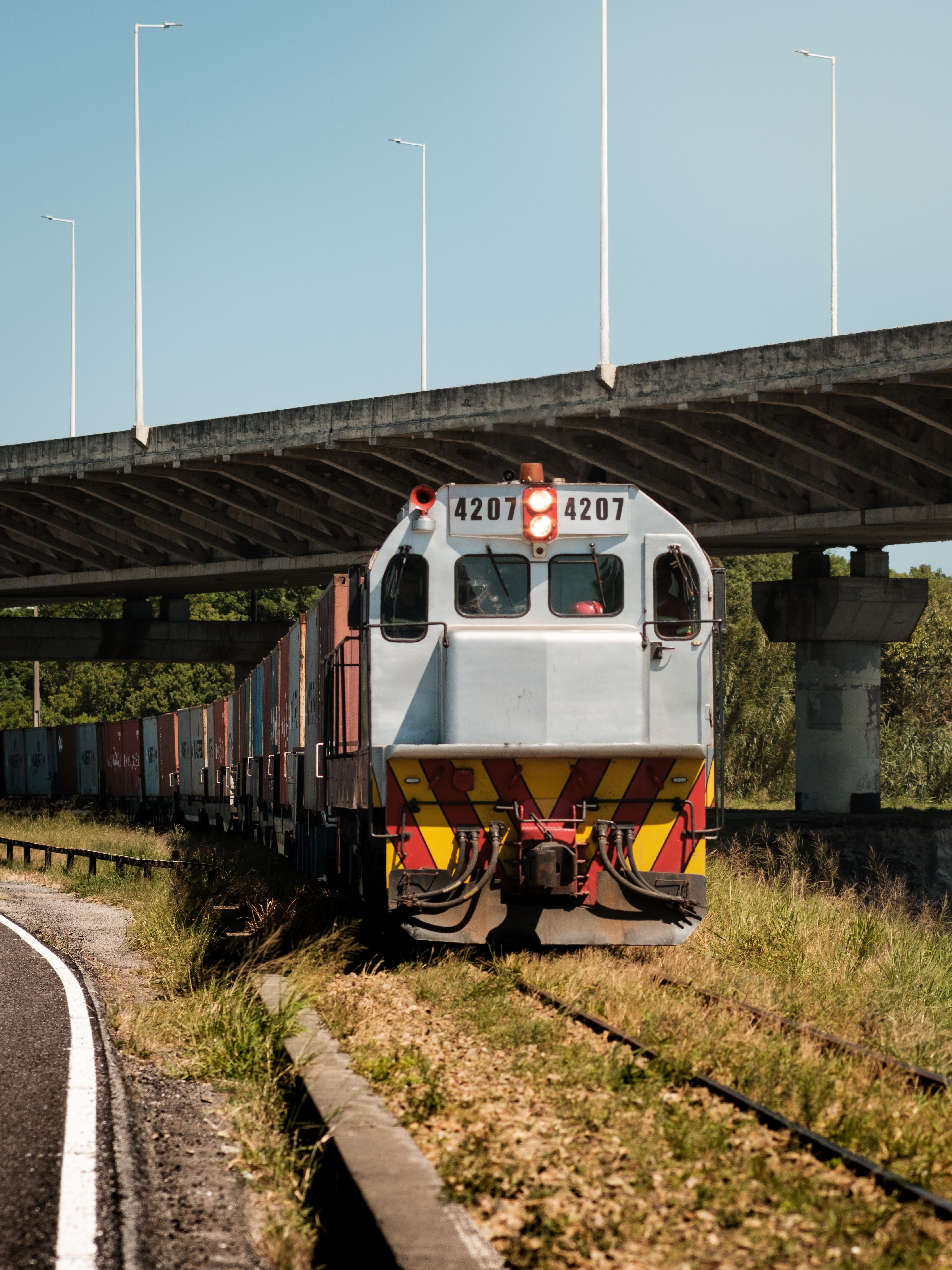 Freight Train Under a Bridge in Laguna, Brazil · Free Stock Photo