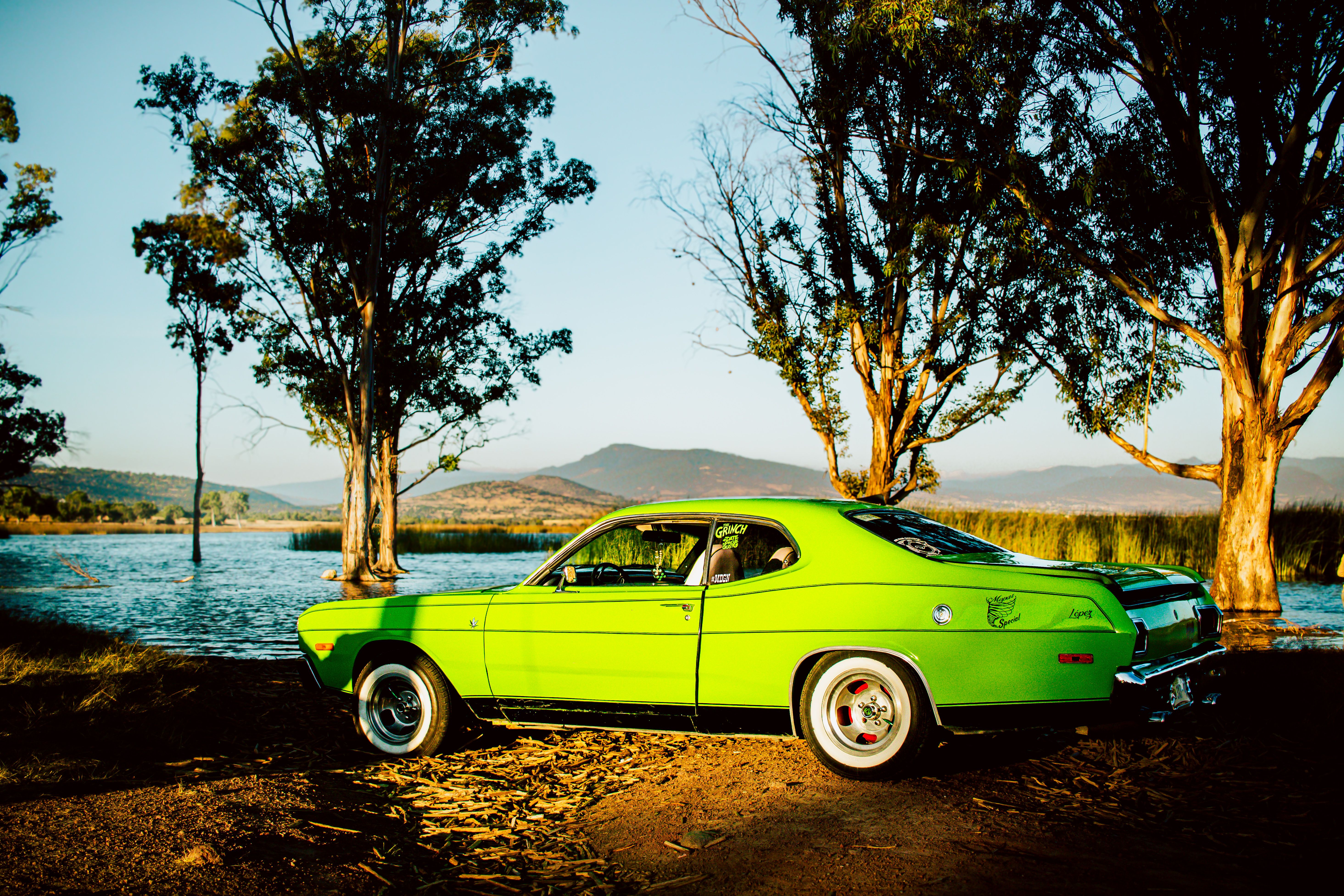 Bright Green Classic Car by a Lakeside Landscape · Free Stock Photo