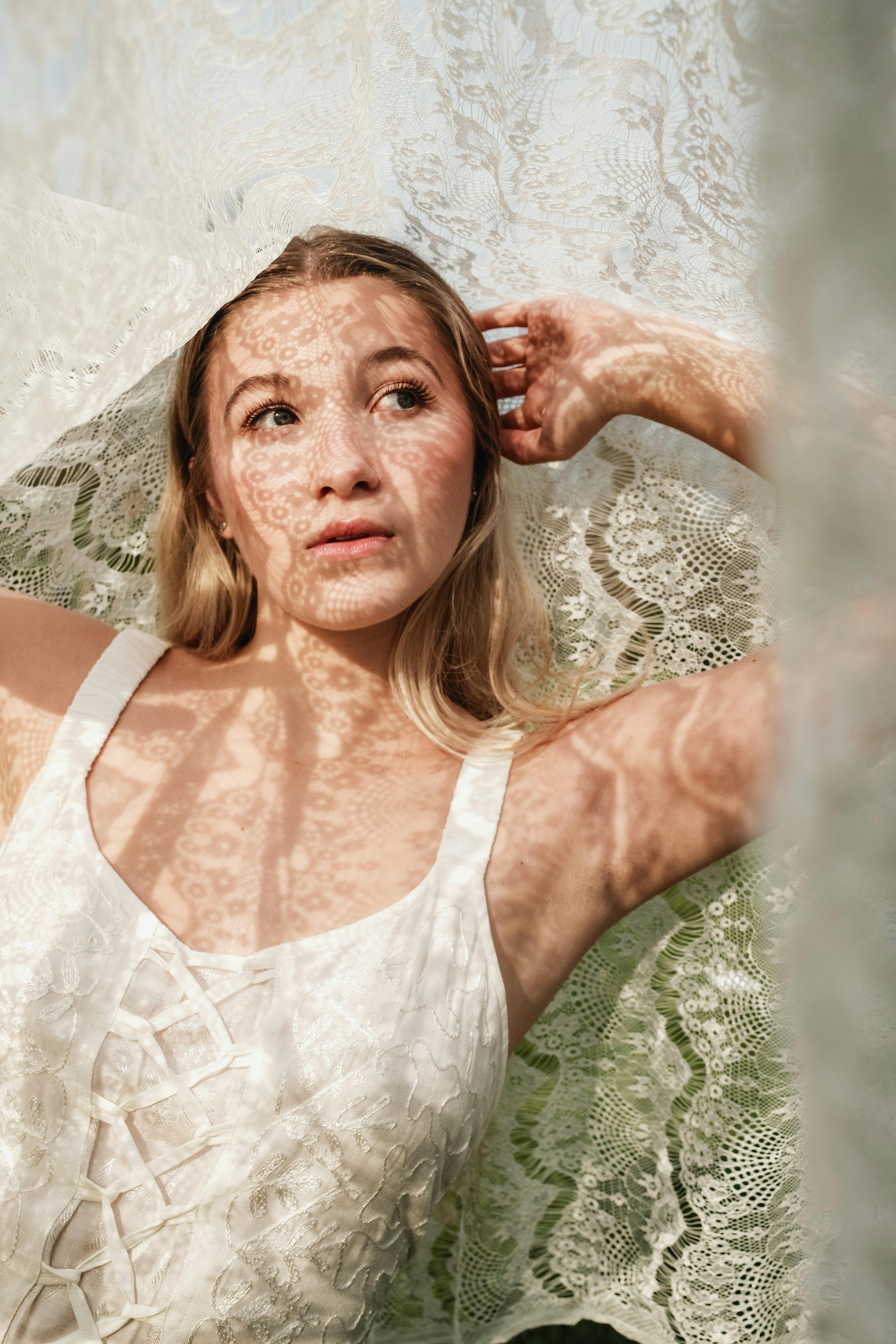 Elegant Portrait of a Woman with Lace Shadows · Free Stock Photo