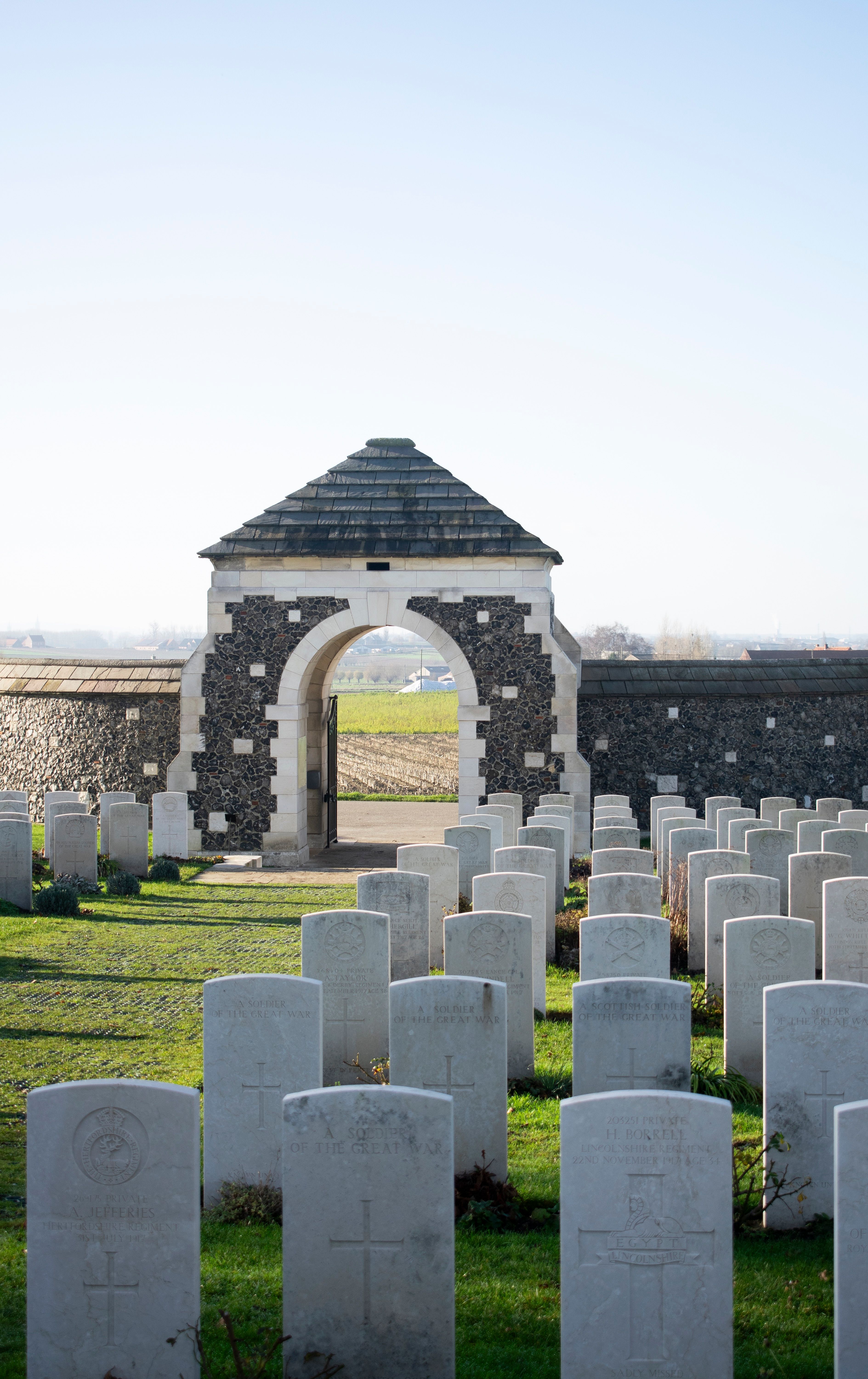 Historic War Cemetery with Stone Archway · Free Stock Photo