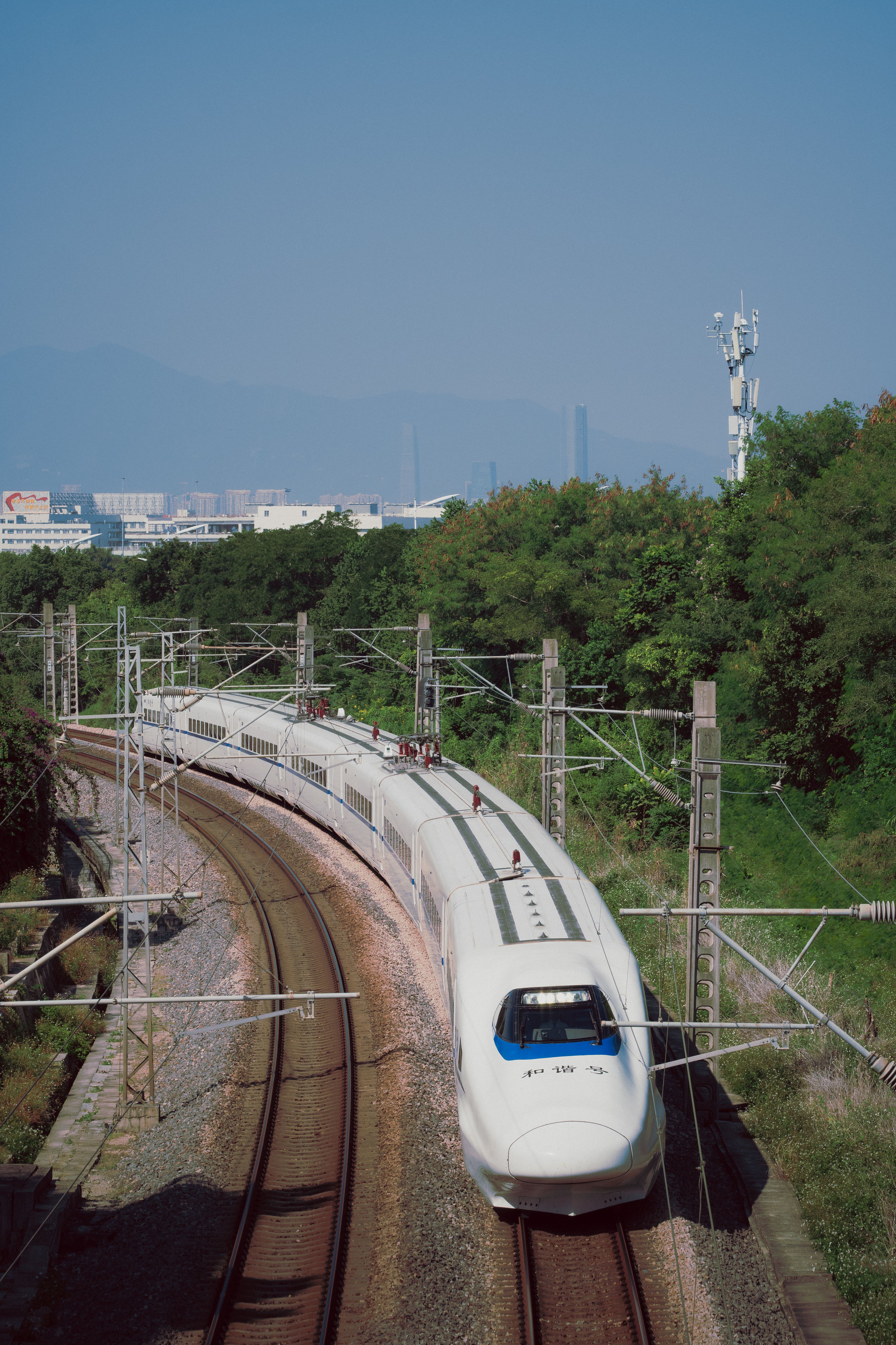 High-Speed Train on Curved Railway Track · Free Stock Photo