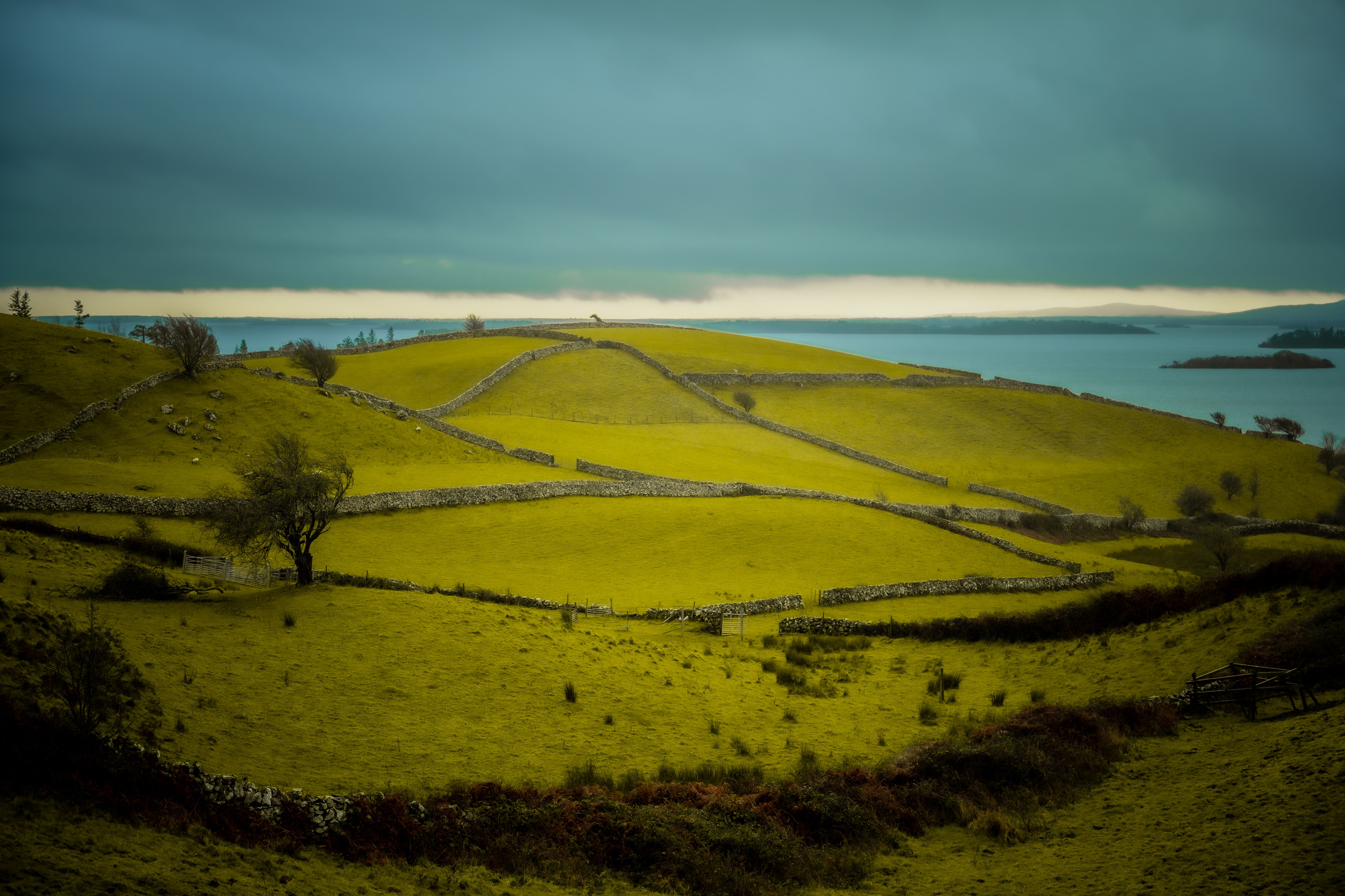 Scenic Rolling Hills and Stone Fences by Lake · Free Stock Photo
