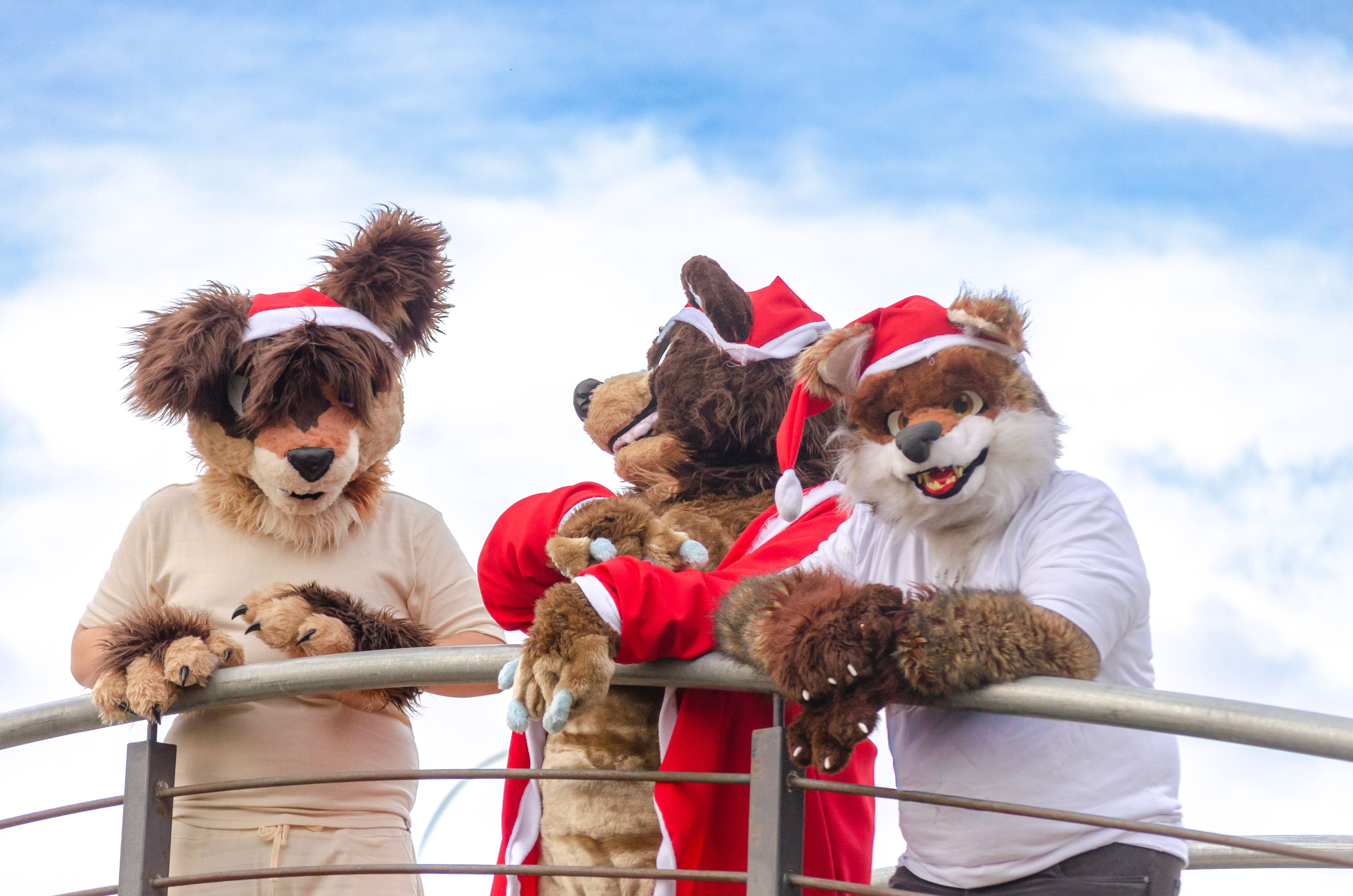 Furry Characters in Santa Hats on a Balcony · Free Stock Photo