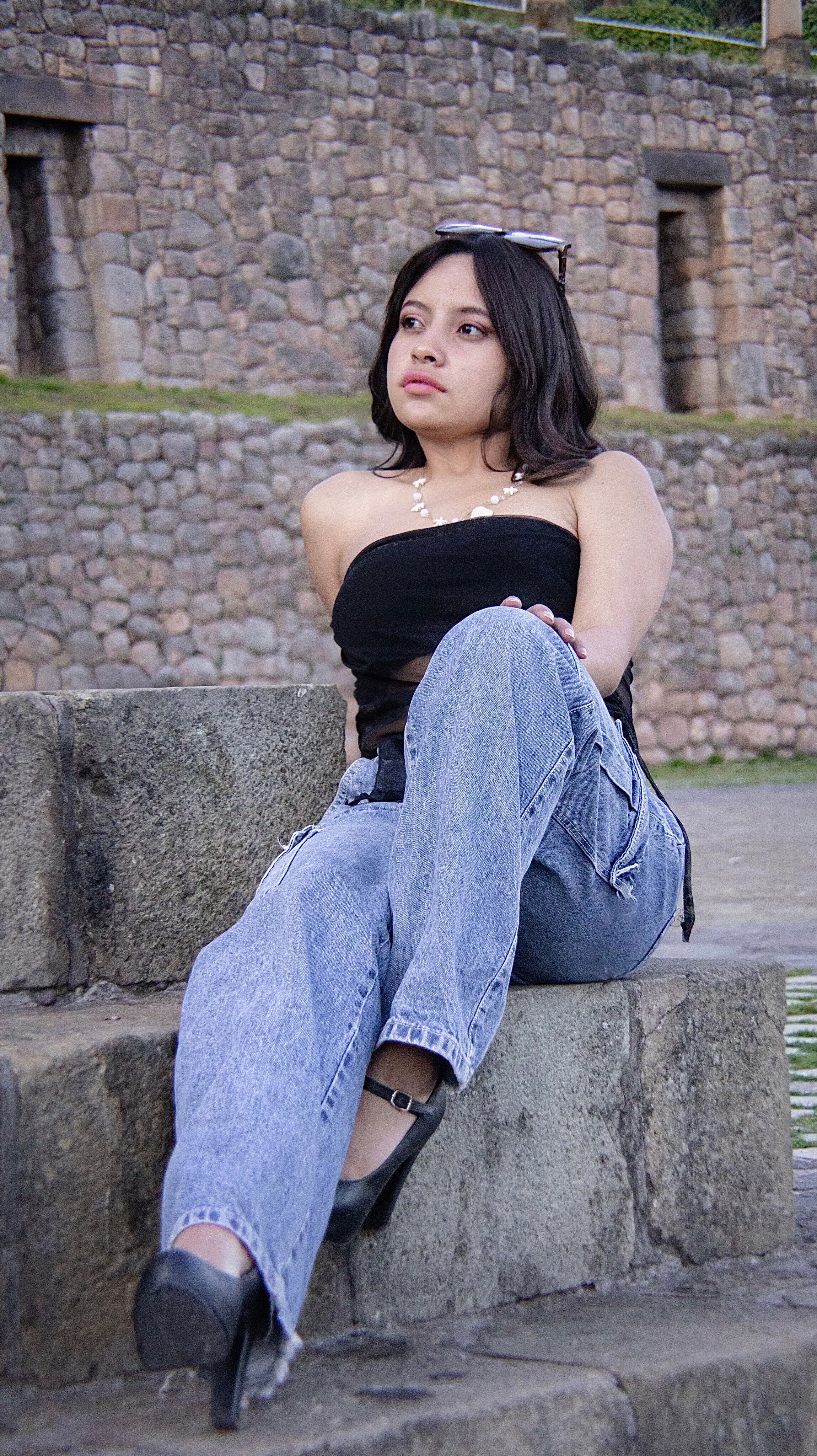 Stylish Woman Relaxing on Stone Steps Outdoors · Free Stock Photo