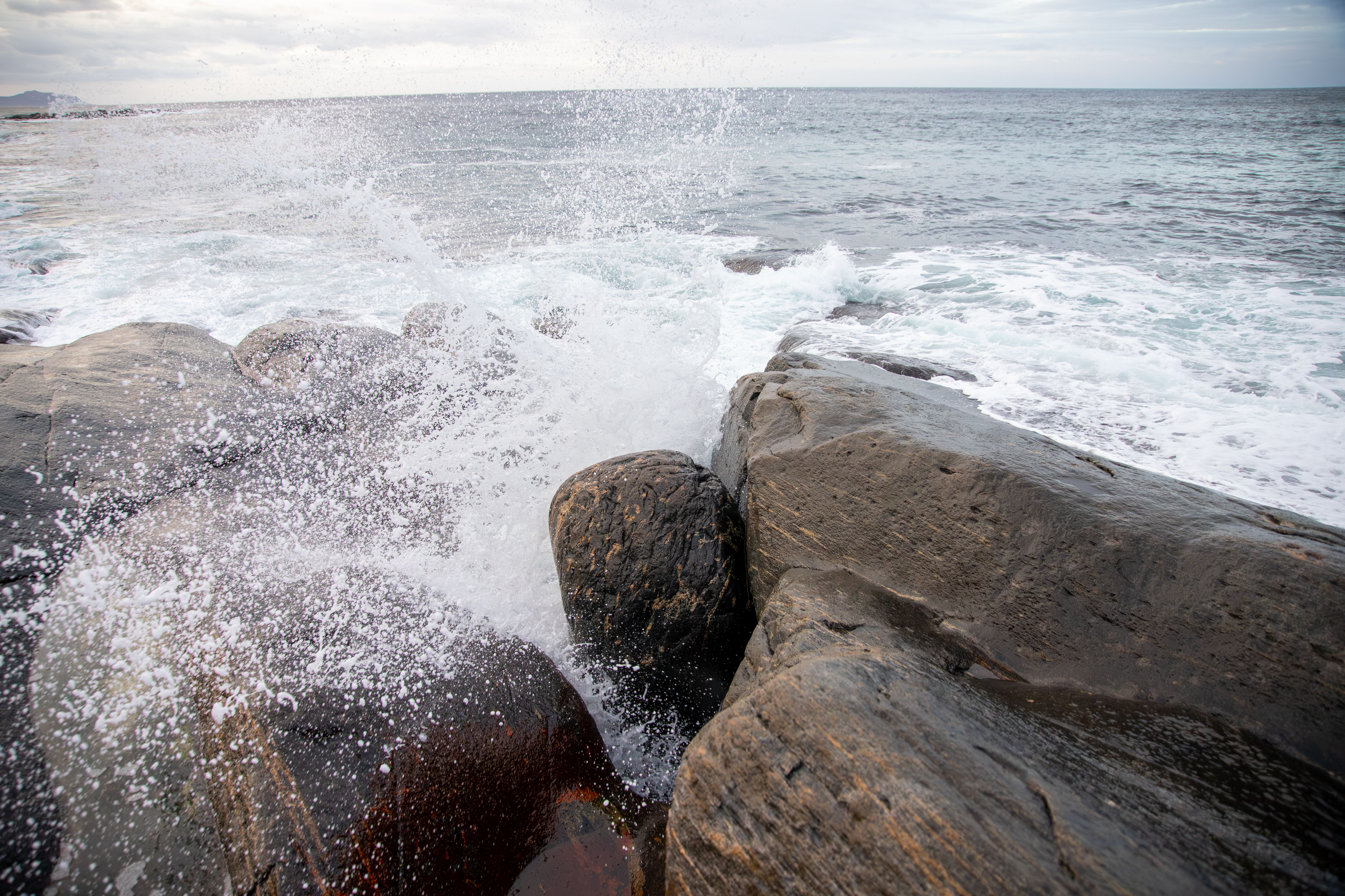 Dynamic Ocean Waves Crashing on Coastal Rocks · Free Stock Photo