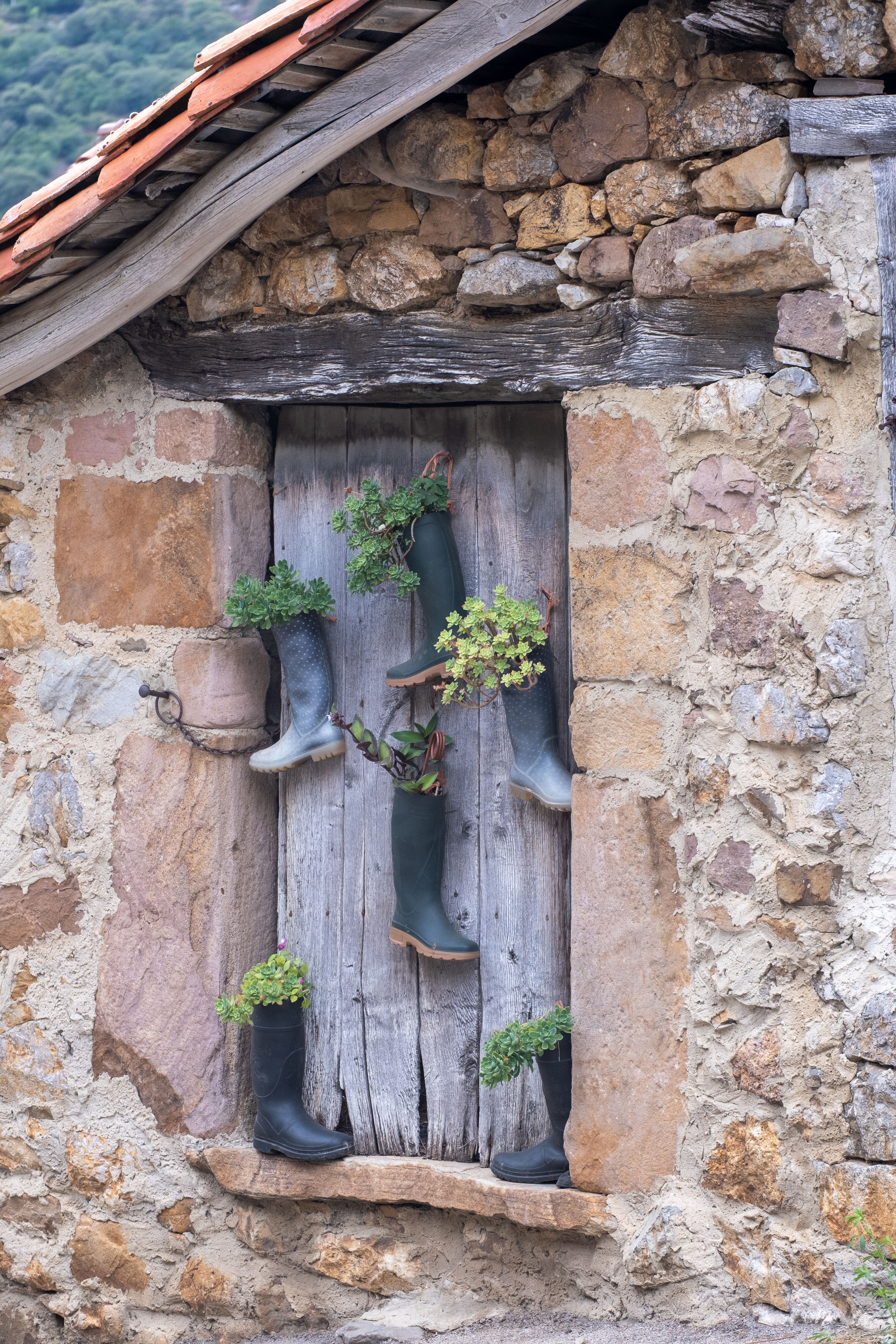 Rustic Boot Planters on Stone Wall · Free Stock Photo