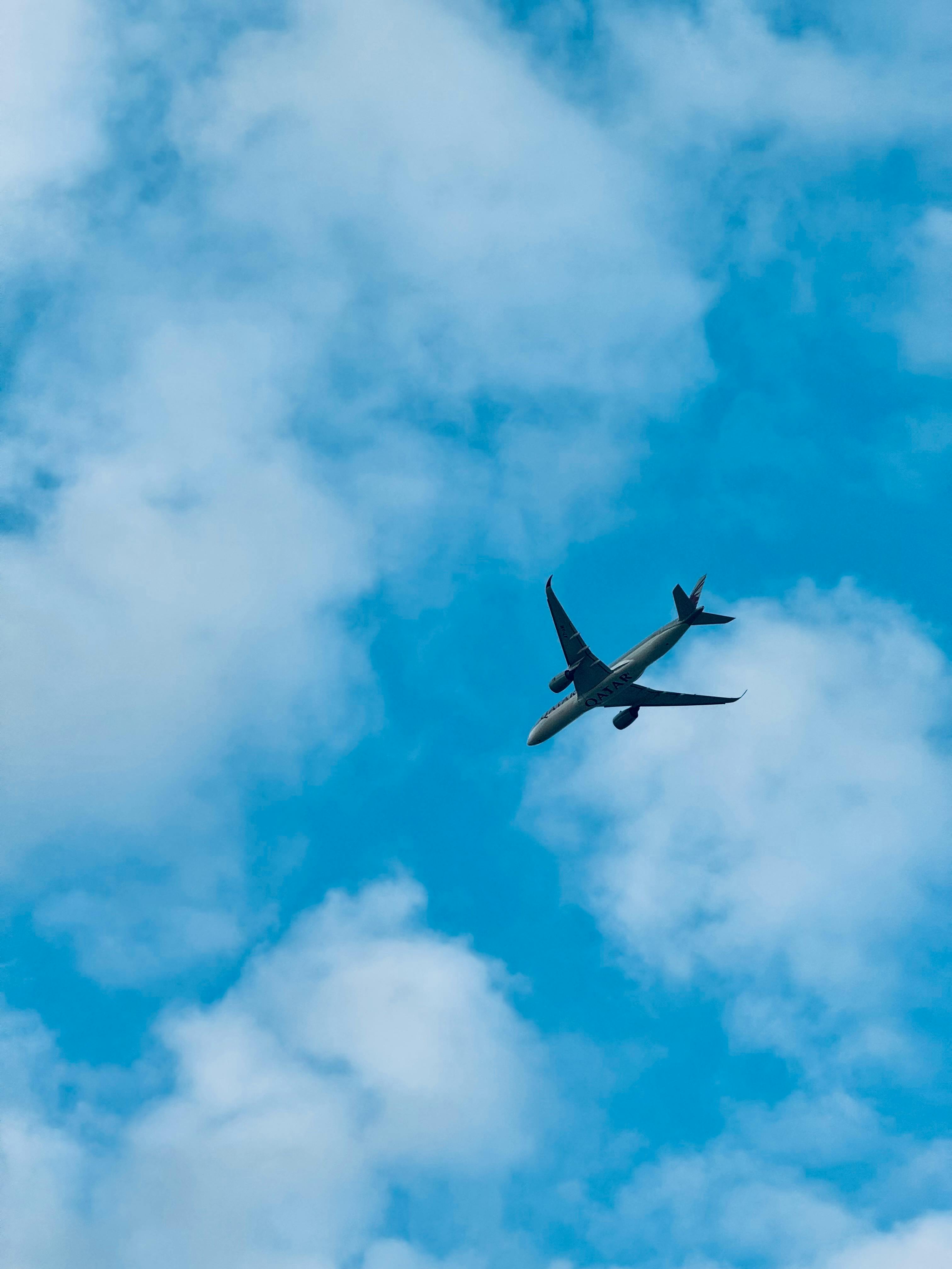 Airplane Flying Above the Clouds in Saudi Blue Sky · Free Stock Photo