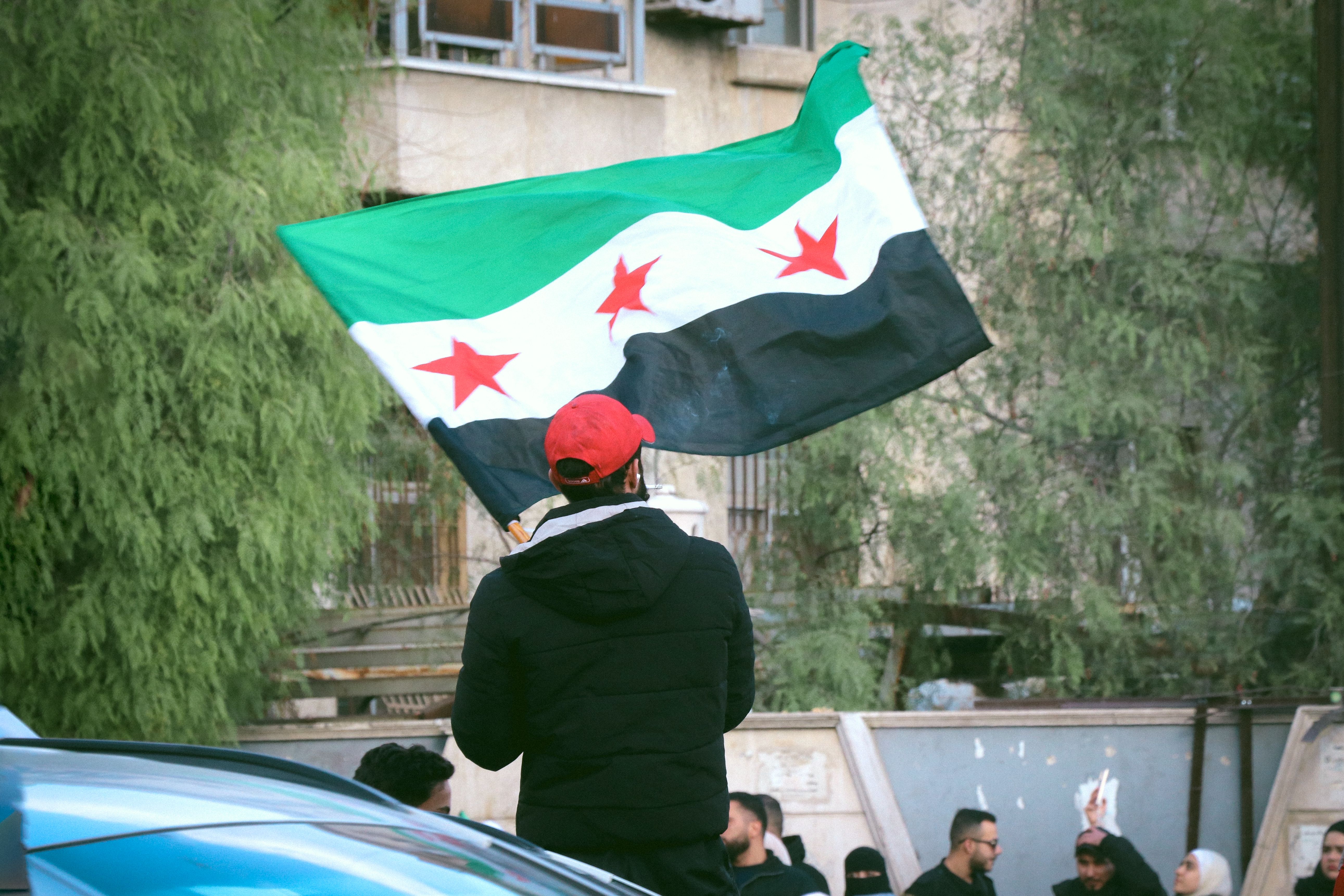Syrian Flag Raised in Patriotic Demonstration · Free Stock Photo