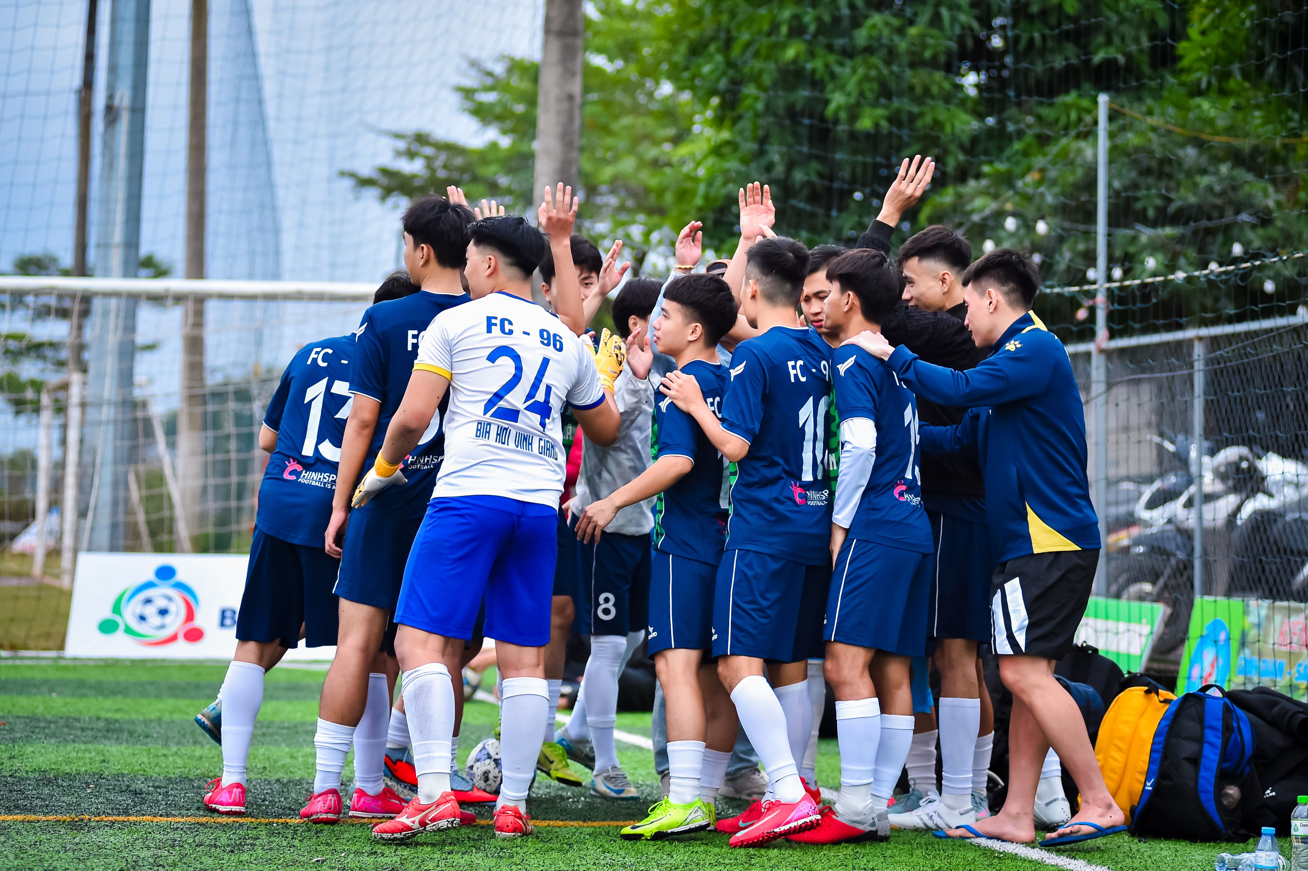 Youth Football Team Huddle on Field in Hanoi · Free Stock Photo