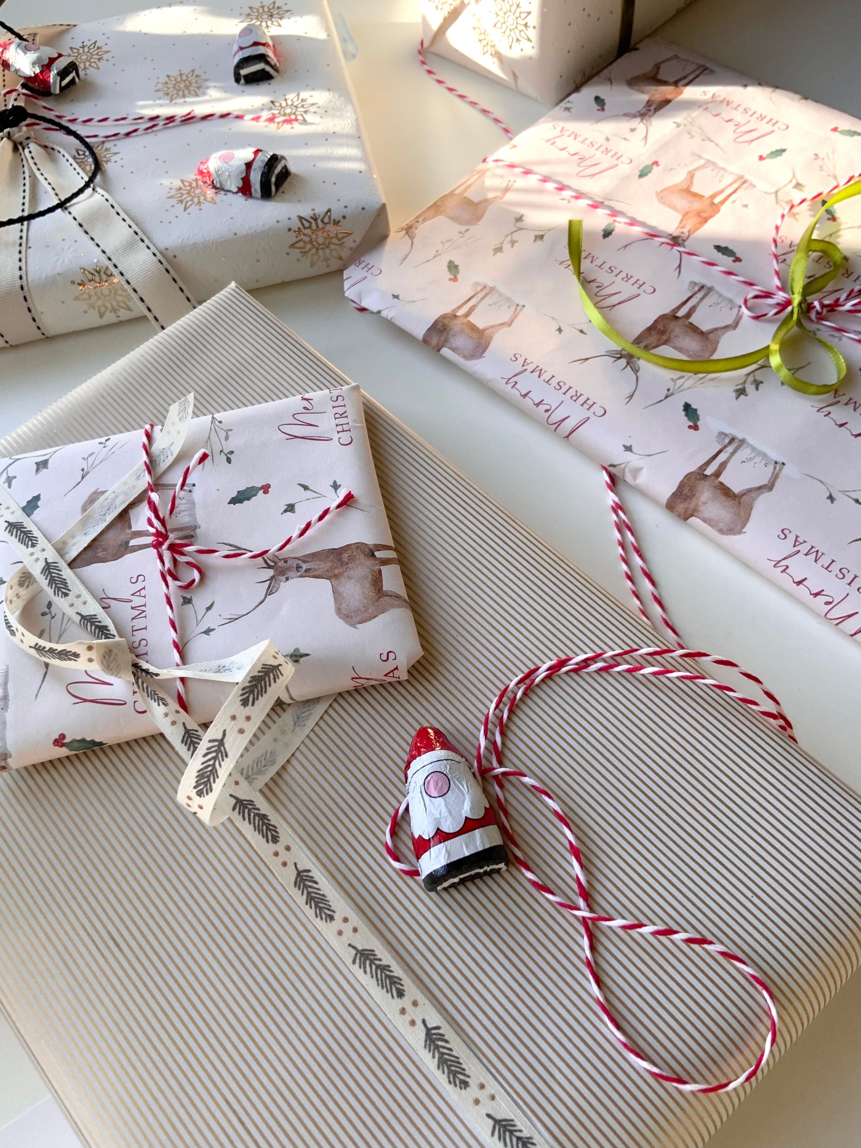 Festive Holiday Gift Wrapping with Decorative Touches · Free Stock Photo