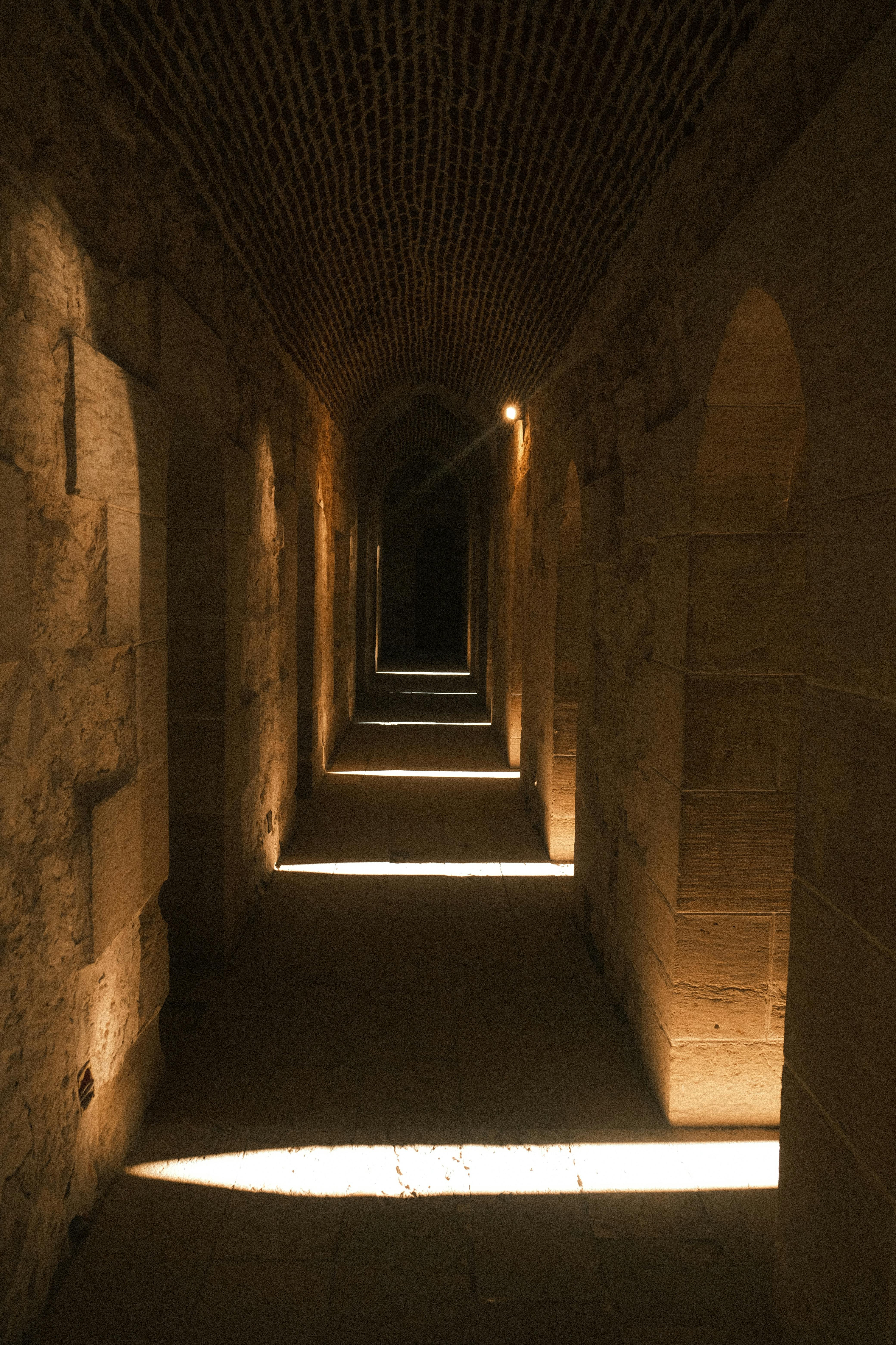 Mystical Stone Corridor with Light Patterns · Free Stock Photo