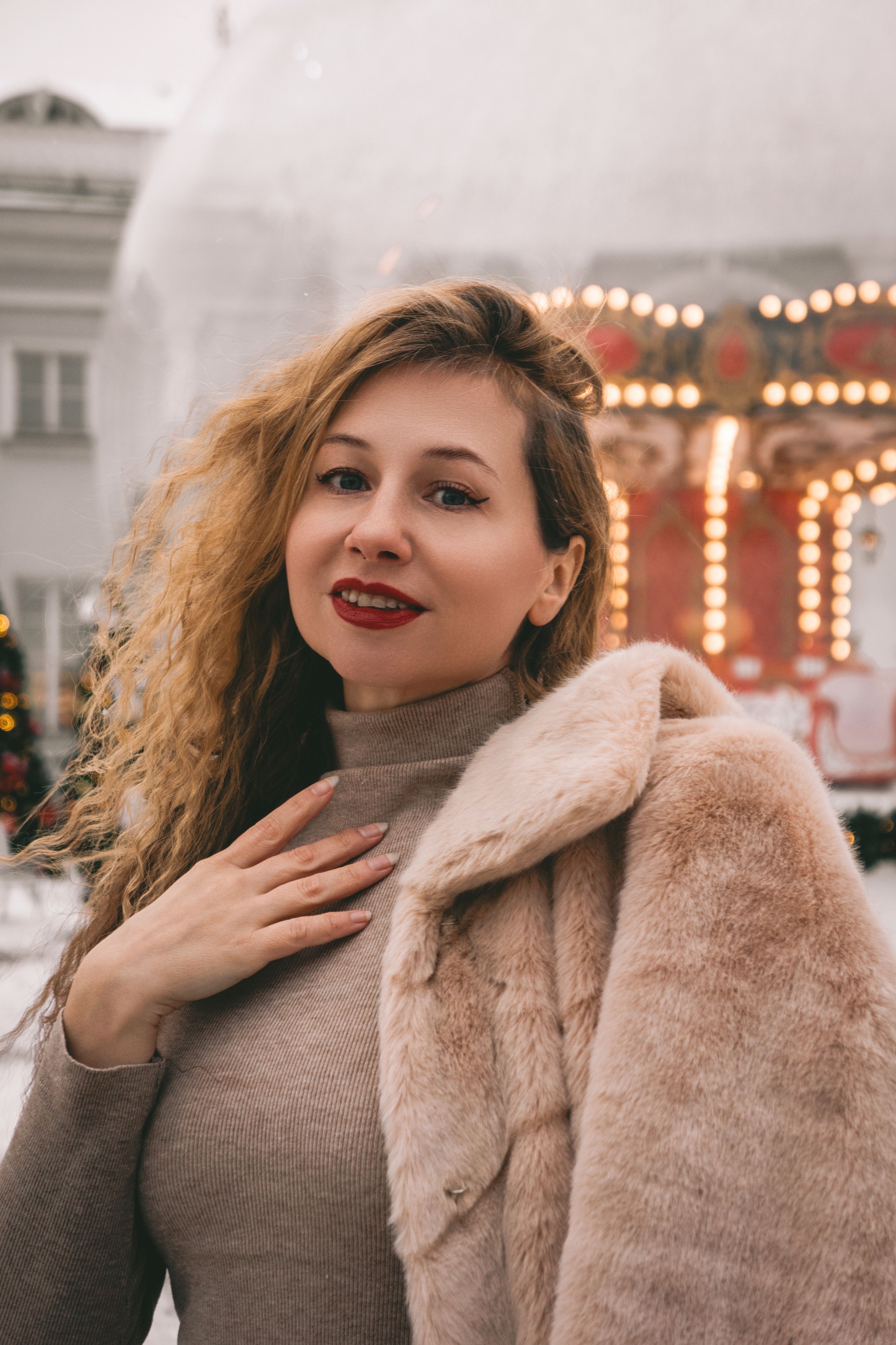 Stylish Woman in Winter Clothing with Carousel · Free Stock Photo