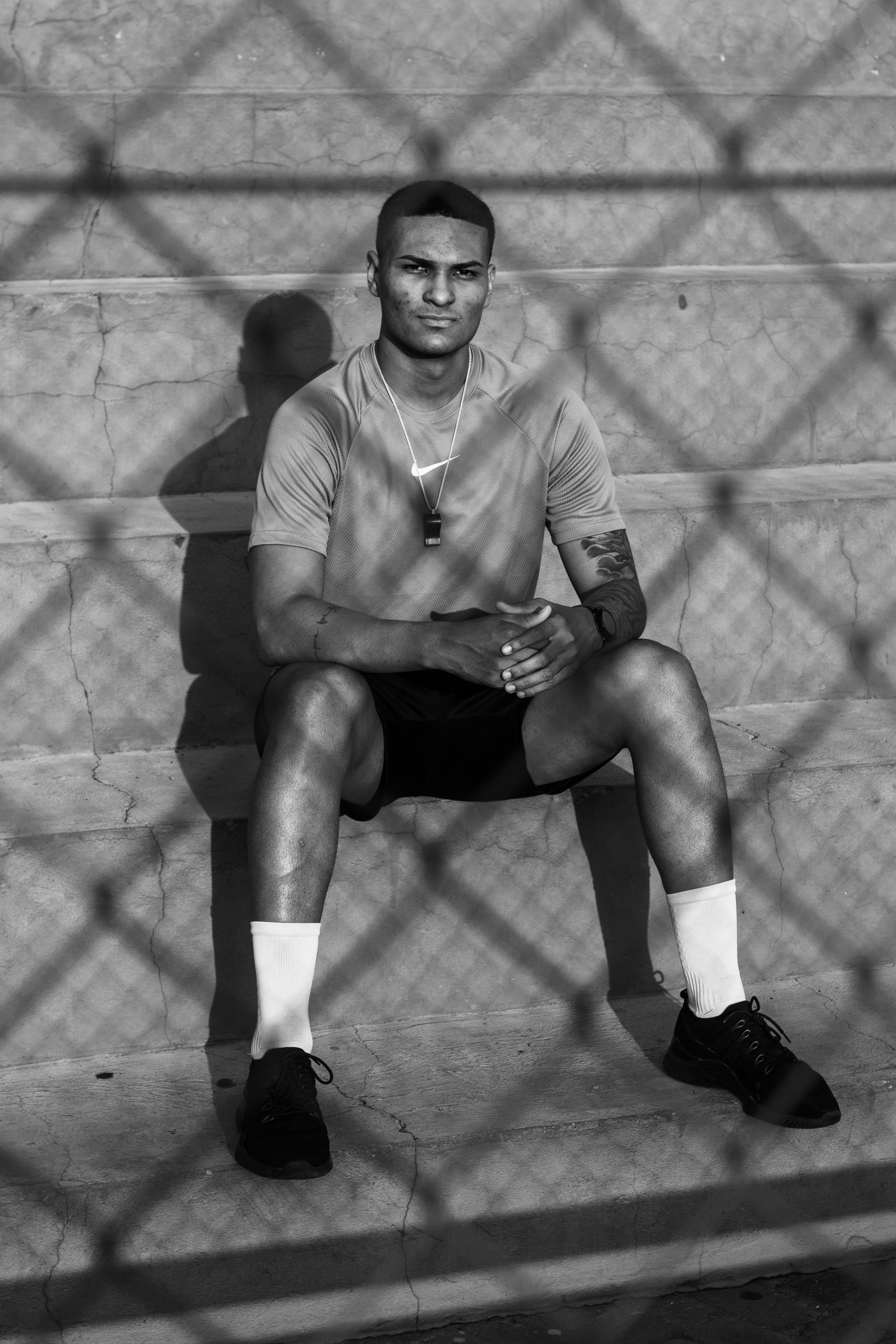 Monochrome Portrait of a Man Behind Fence · Free Stock Photo