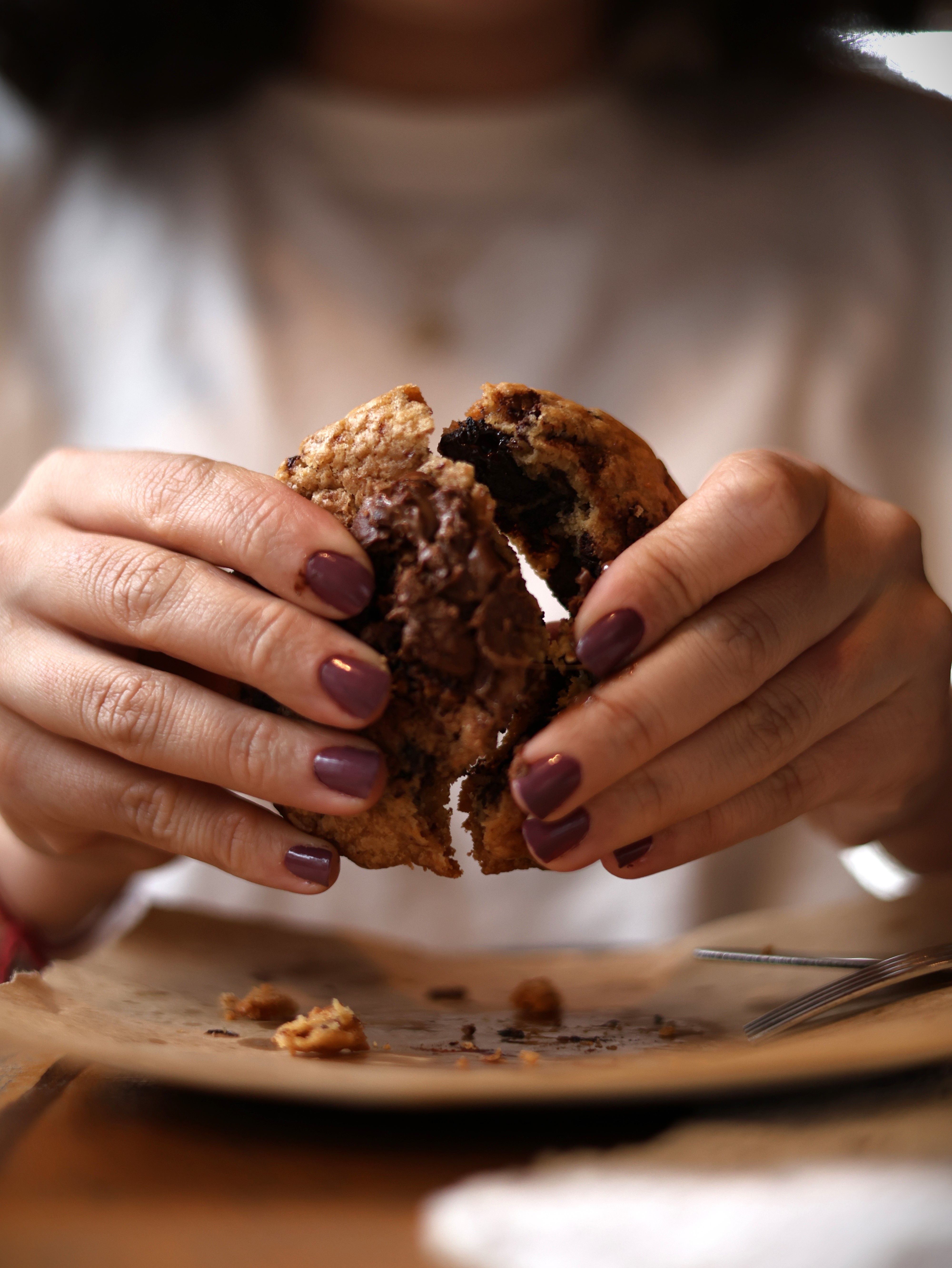 Close-up of Hands Holding Chocolate Cookie · Free Stock Photo