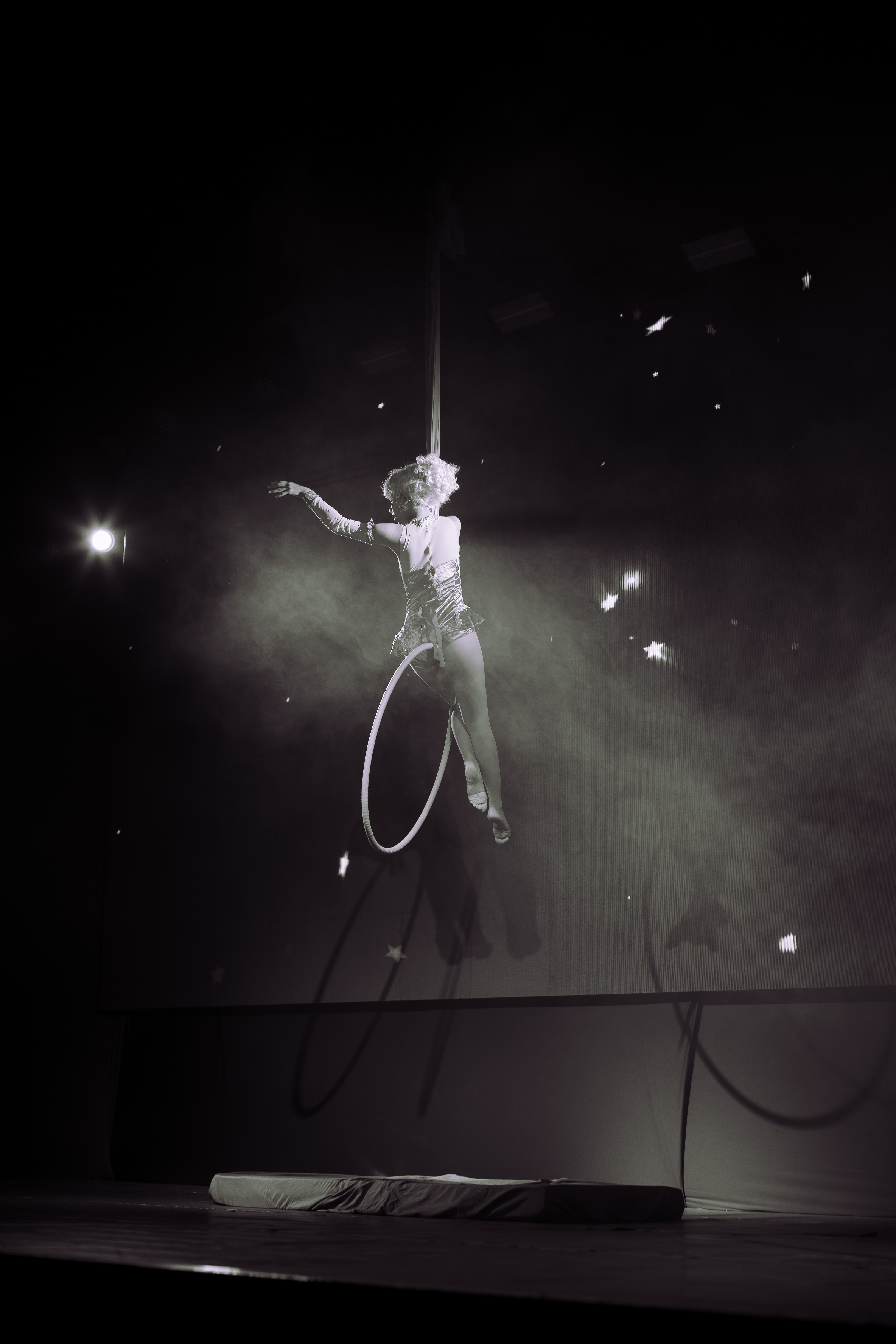 Elegant Aerial Performer in Spotlight with Hoop · Free Stock Photo