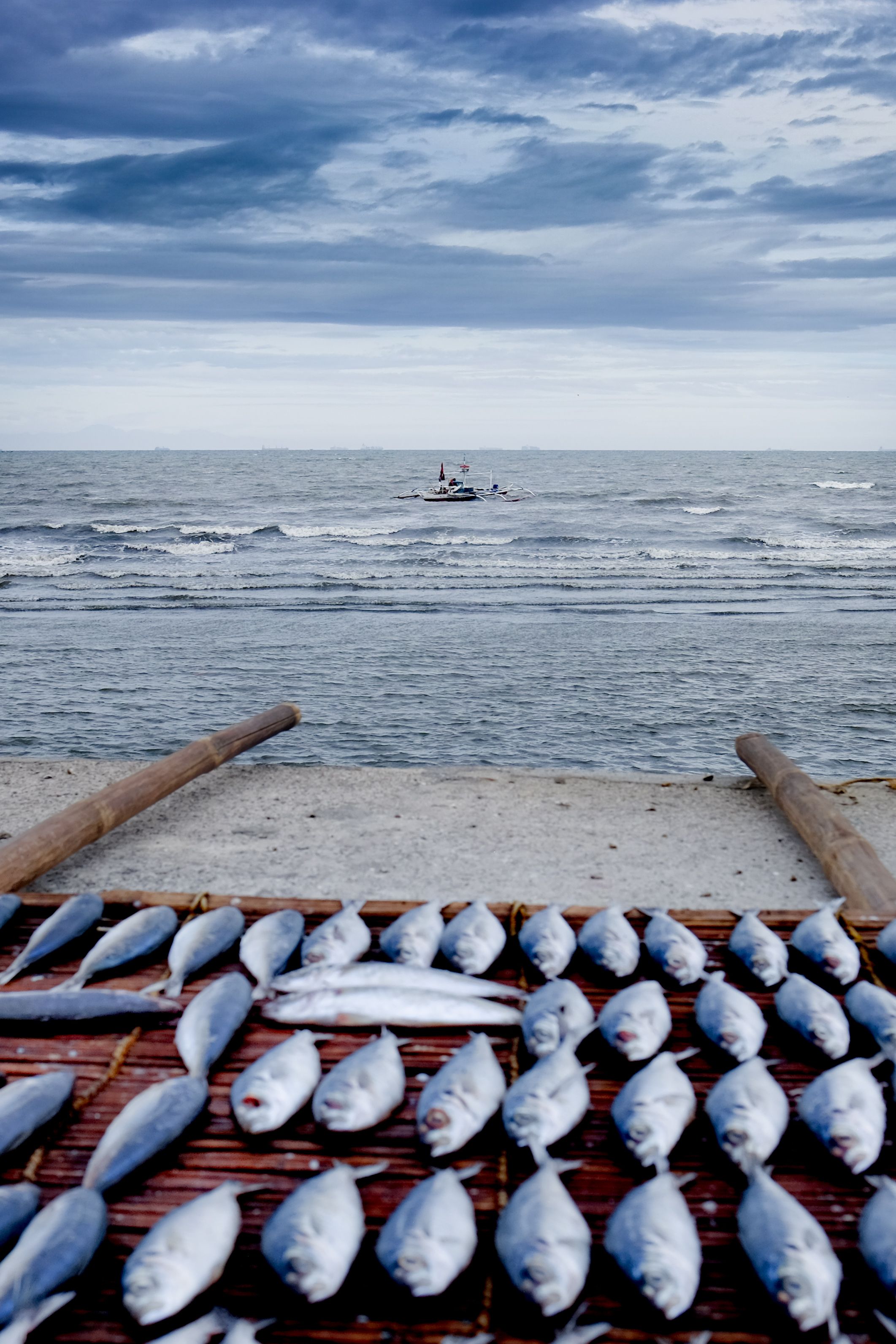 Fishing Boat and Drying Fish in the Philippines · Free Stock Photo