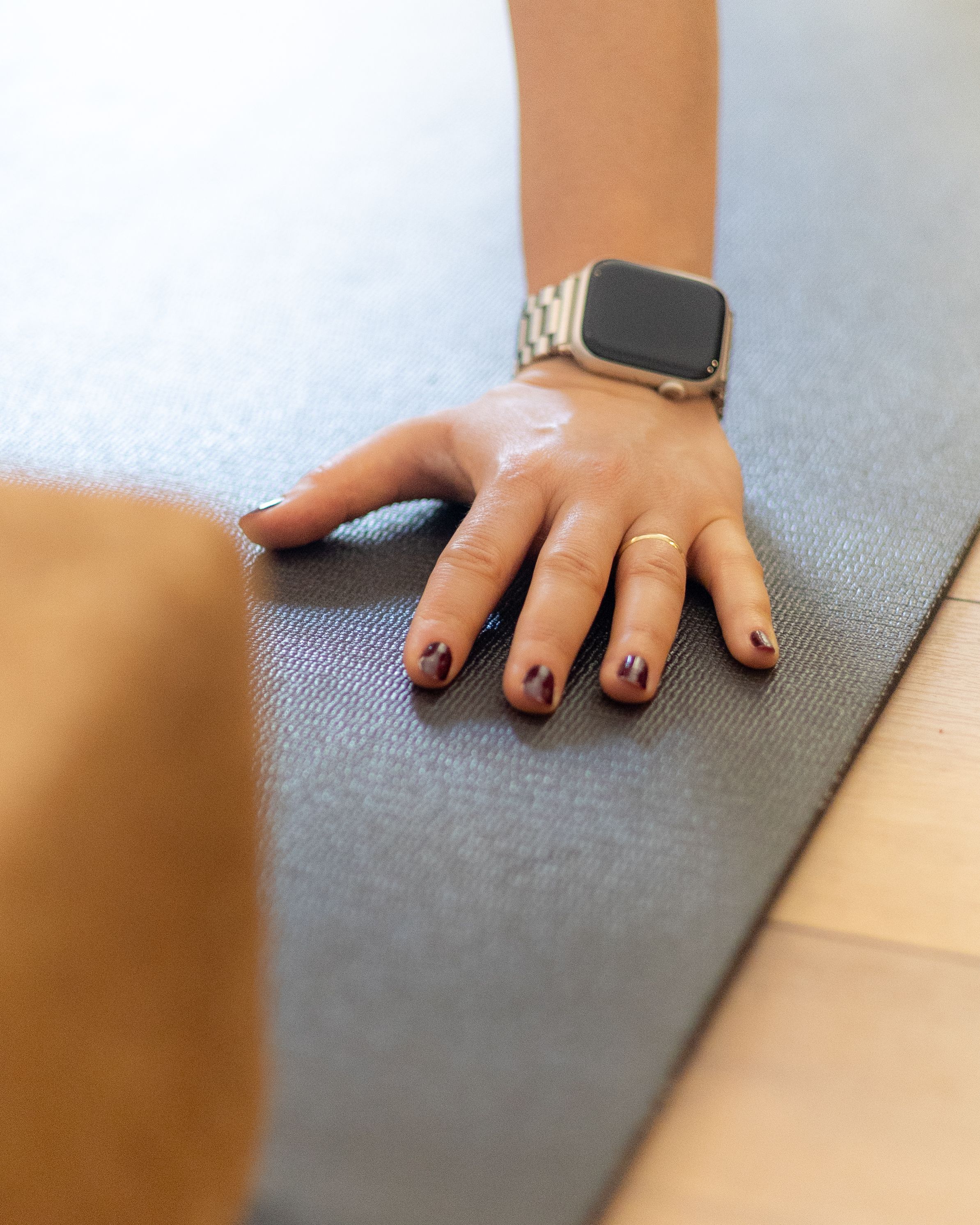 Close-up of a Hand on Yoga Mat with Smartwatch · Free Stock Photo