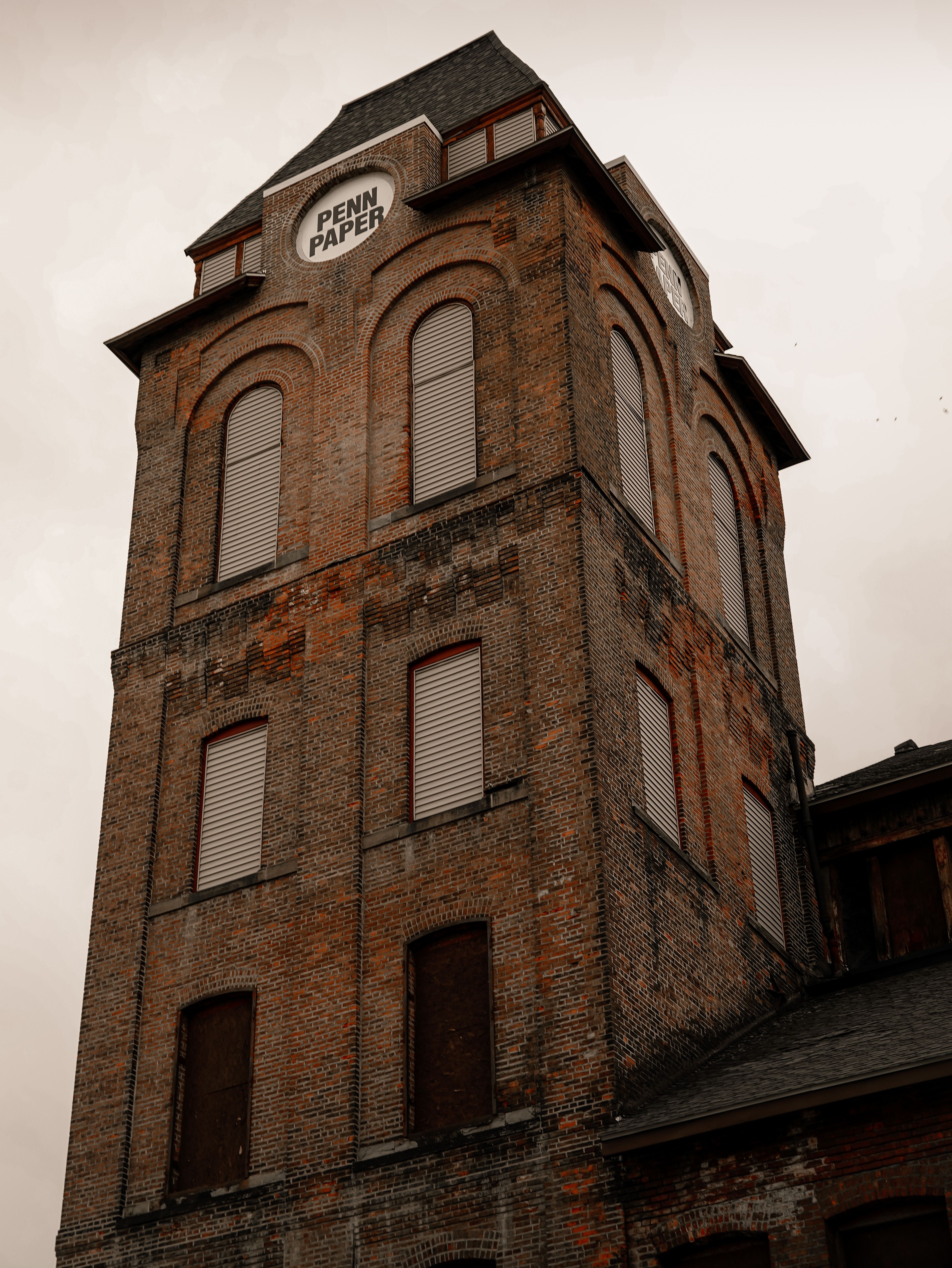 Historic Penn Paper Brick Tower against Cloudy Sky · Free Stock Photo