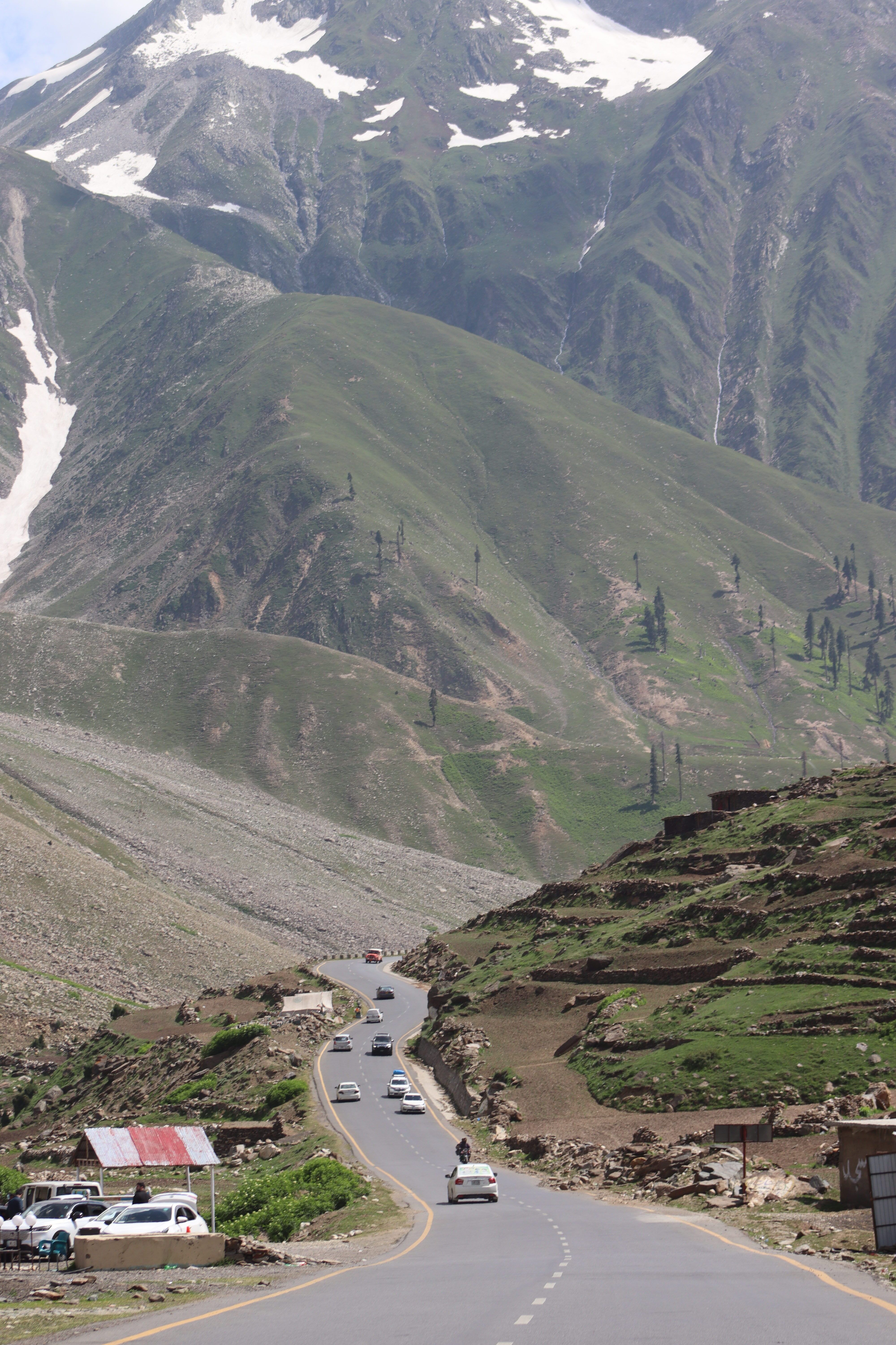 Scenic Mountain Road with Snow-Capped Peaks · Free Stock Photo