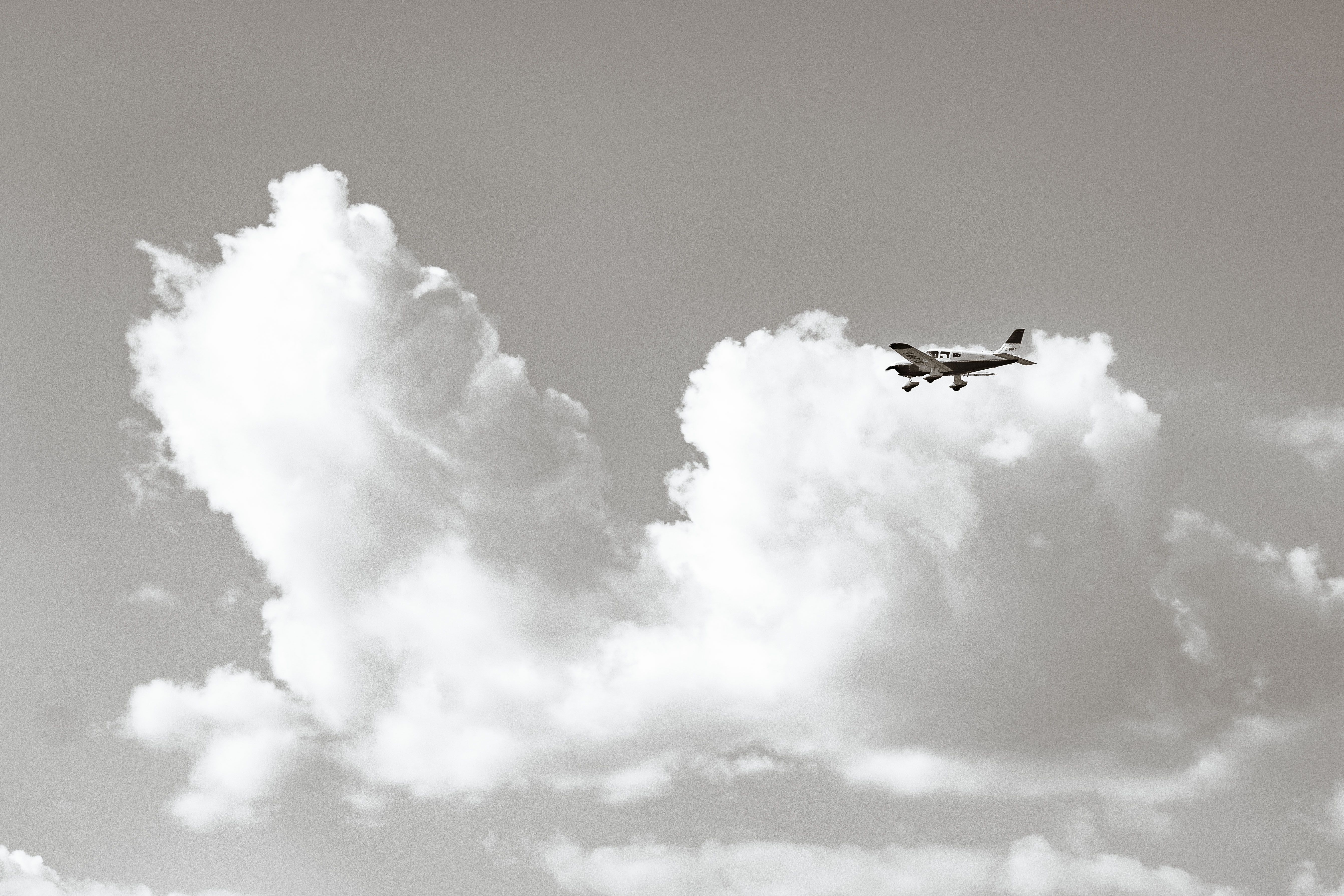 Small Plane Flying Above Clouds in Ontario Sky · Free Stock Photo