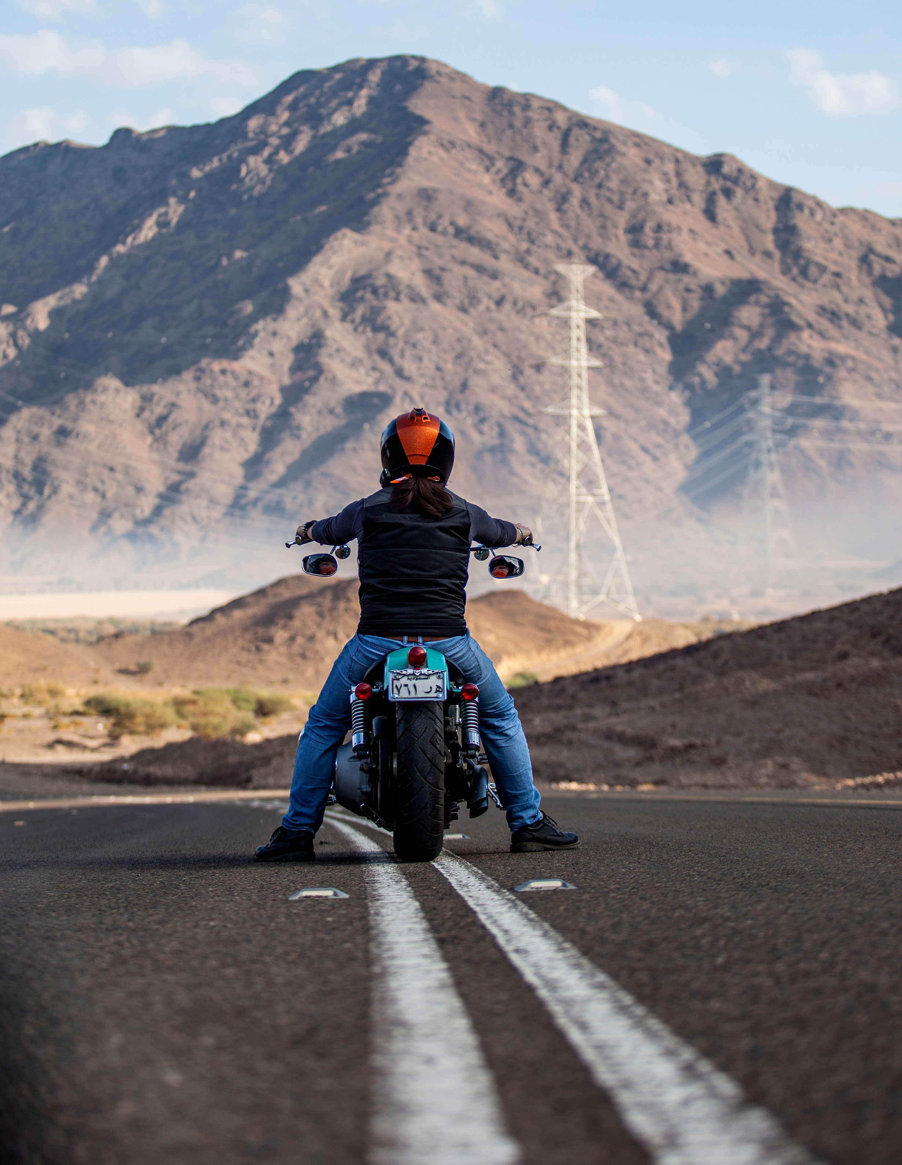 Rider on Motorcycle Facing Majestic Mountain · Free Stock Photo