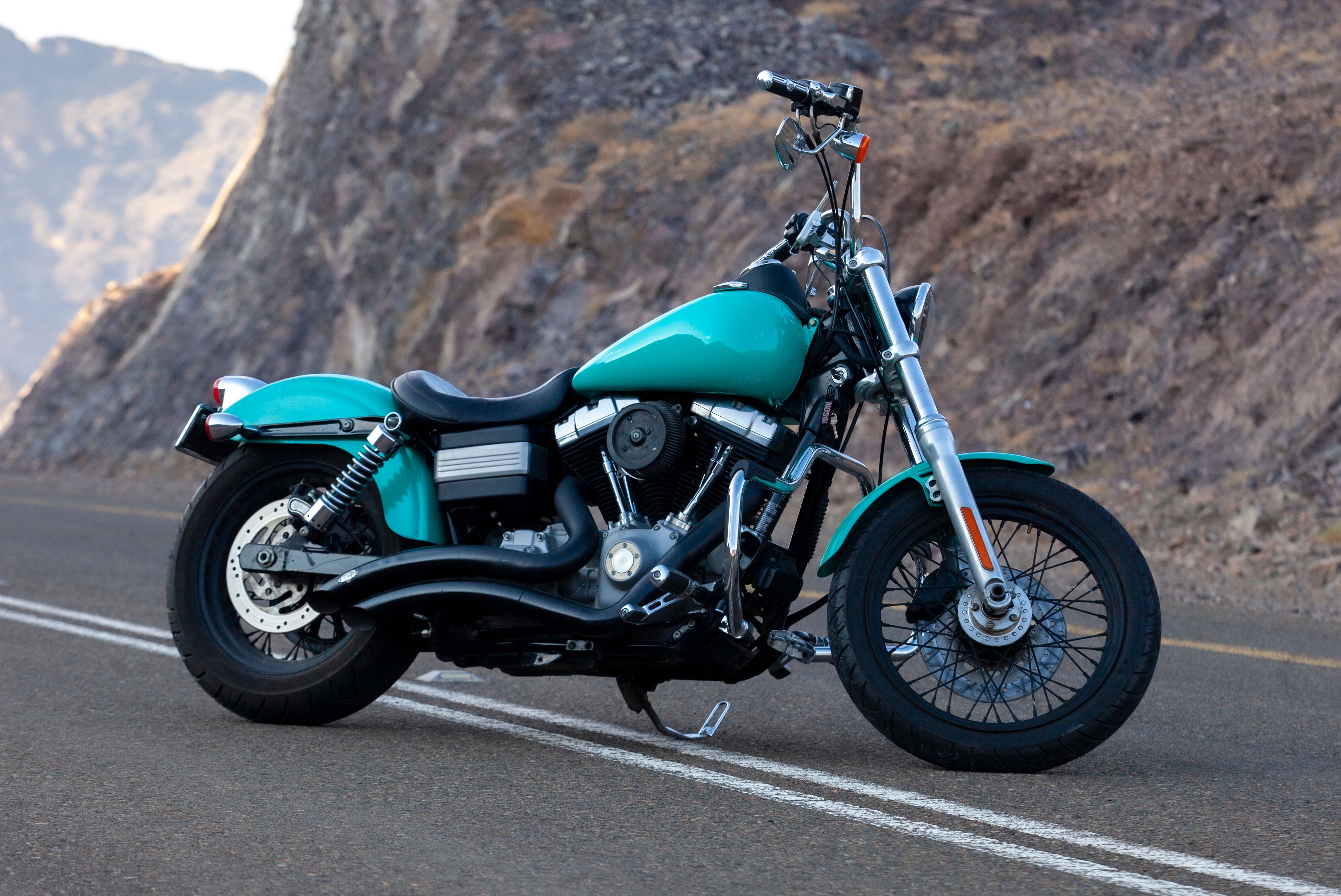 Turquoise Motorcycle on Mountain Road · Free Stock Photo