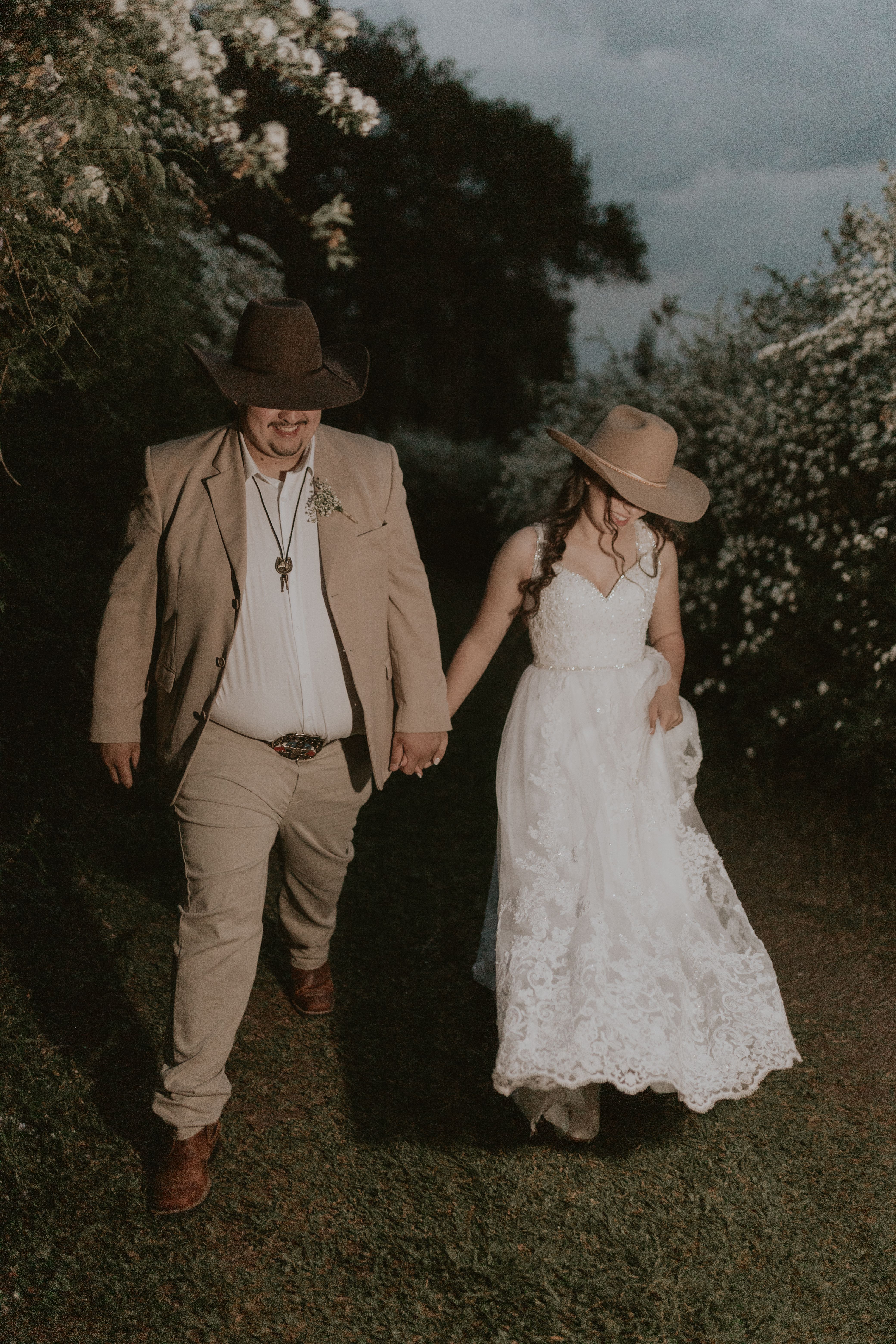 Rustic Wedding Couple Walking Outdoors at Dusk · Free Stock Photo