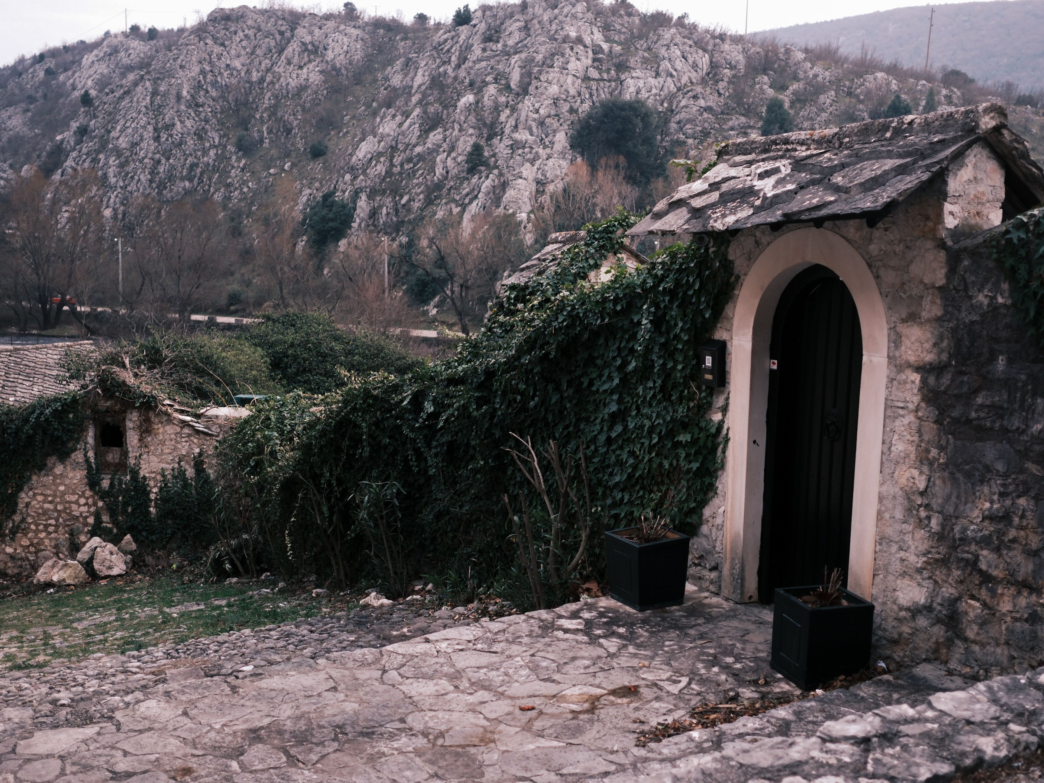 Rustic Stone House with Ivy in Mountainous Landscape · Free Stock Photo
