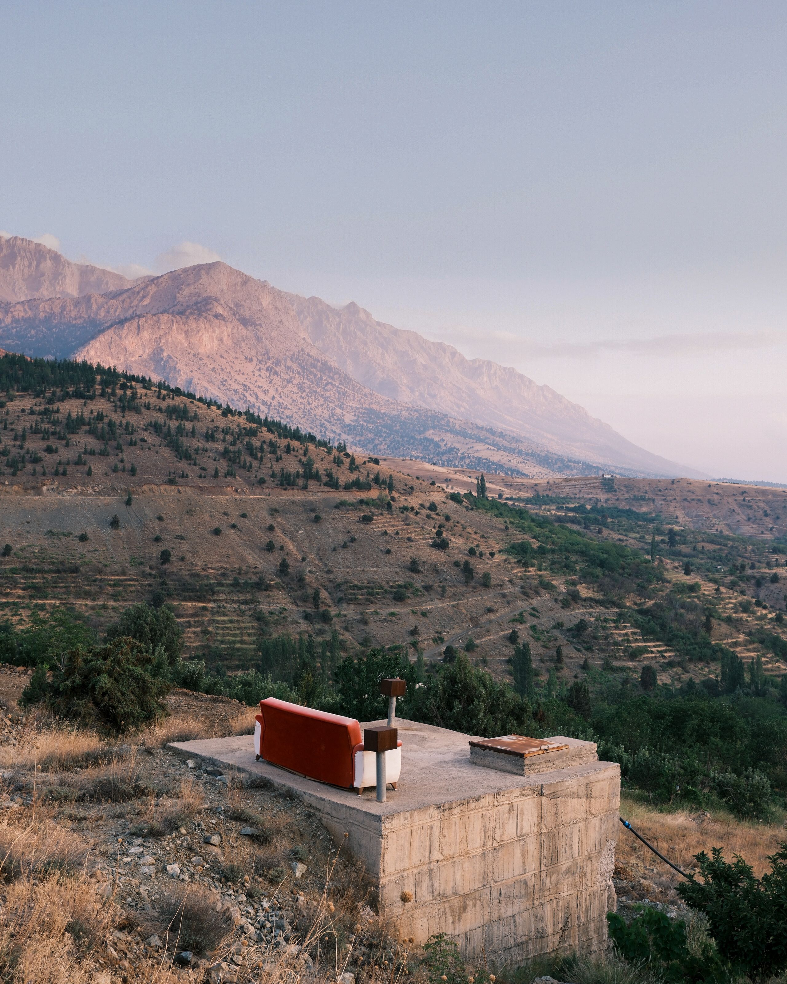 Solitary Couch Overlooks Majestic Mountain Landscape · Free Stock Photo