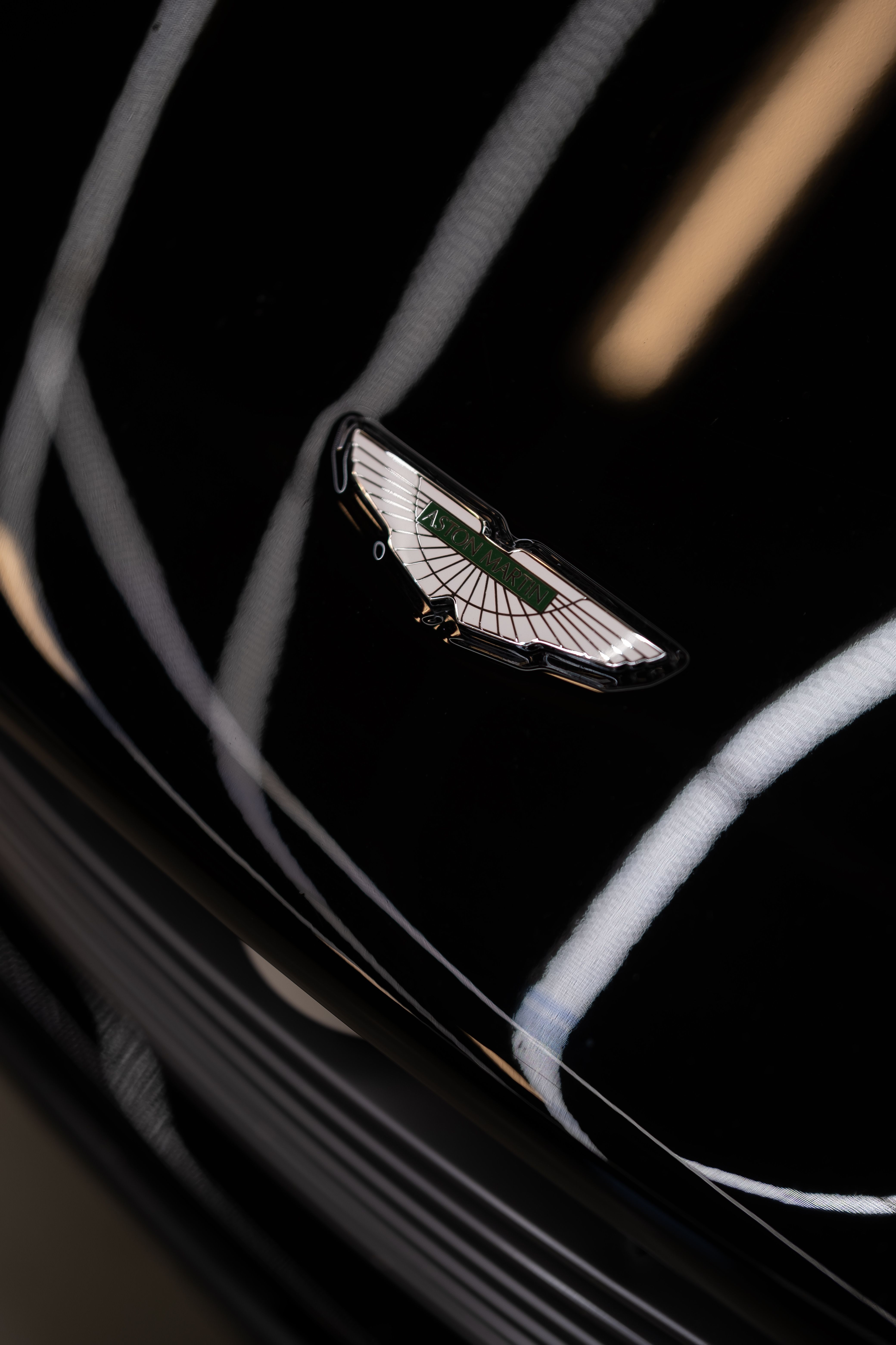 Close-up of Luxury Car Emblem on Black Surface · Free Stock Photo