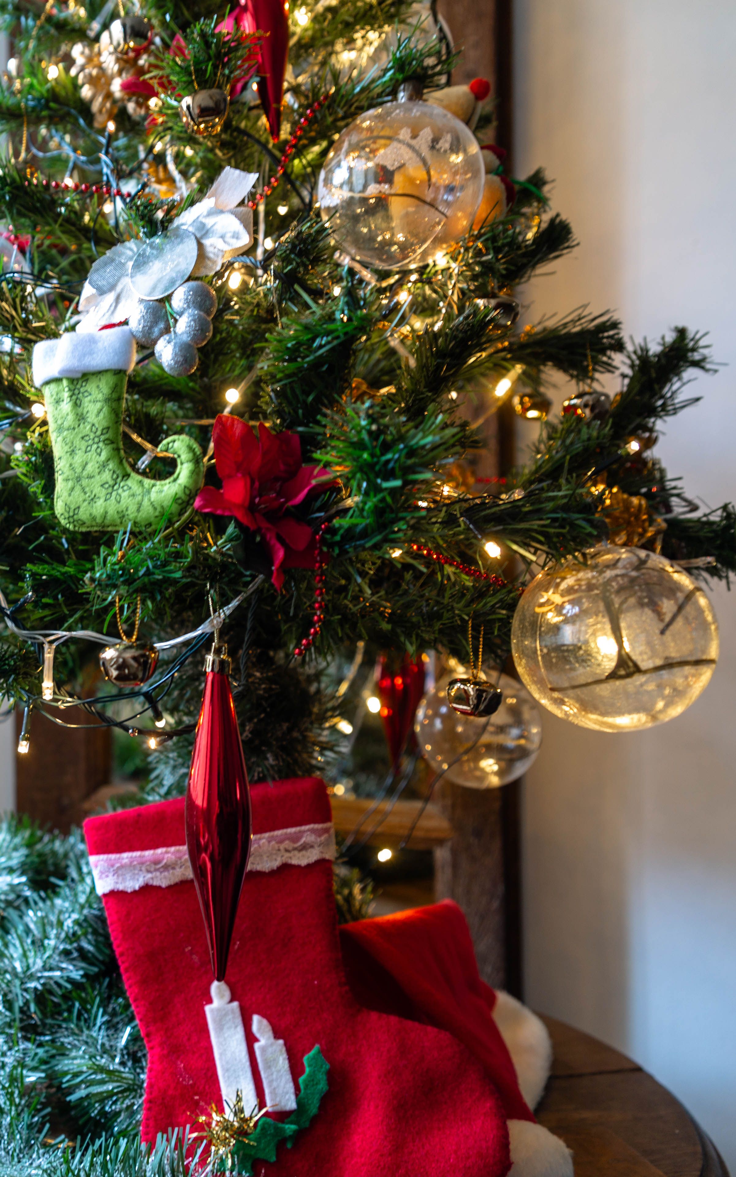 Festive Christmas Tree with Stockings and Ornaments · Free Stock Photo