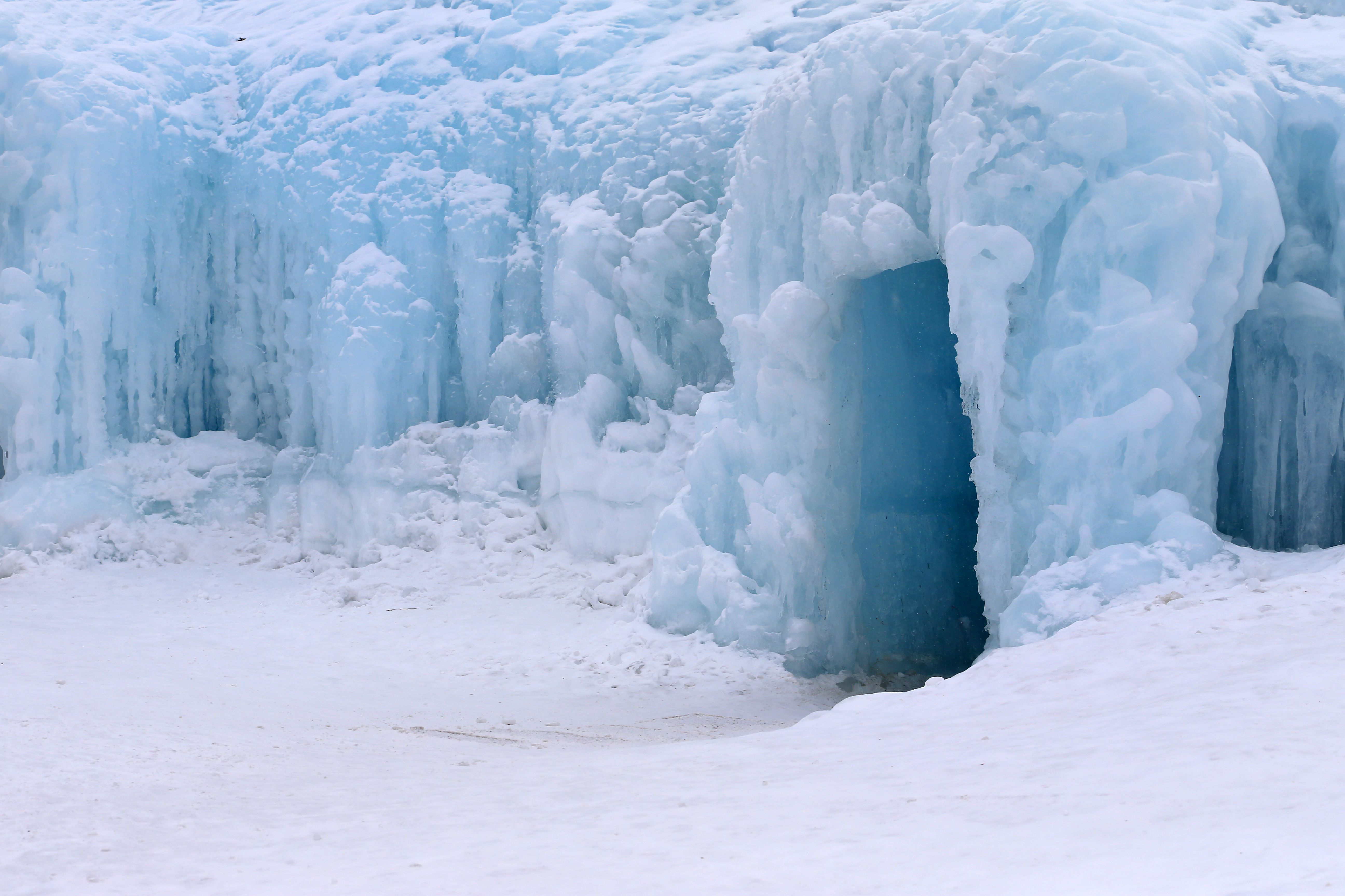 Majestic Ice Cave Entrance in Snowy Landscape · Free Stock Photo