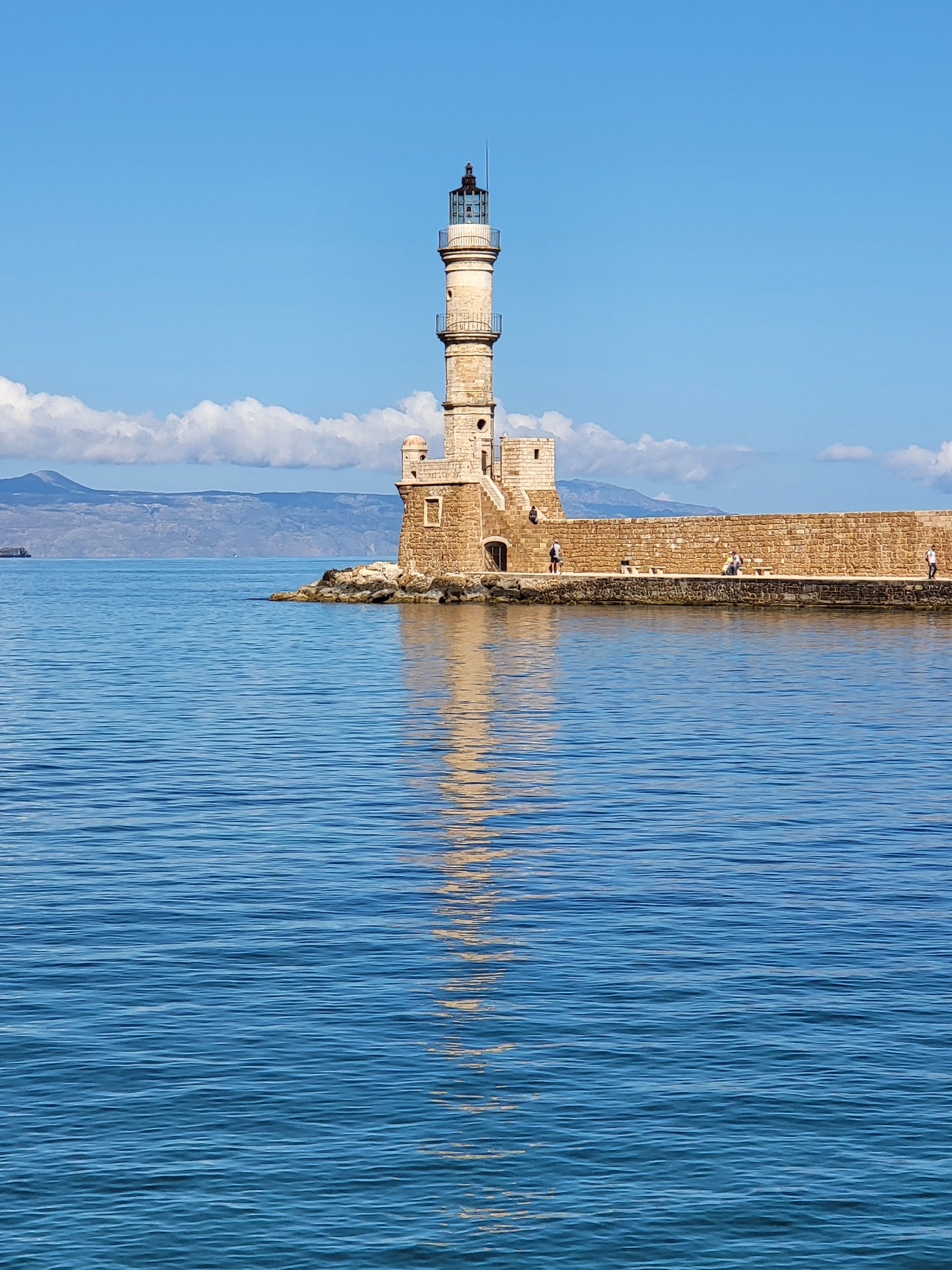 Chania Lighthouse Reflecting on Calm Sea Water · Free Stock Photo