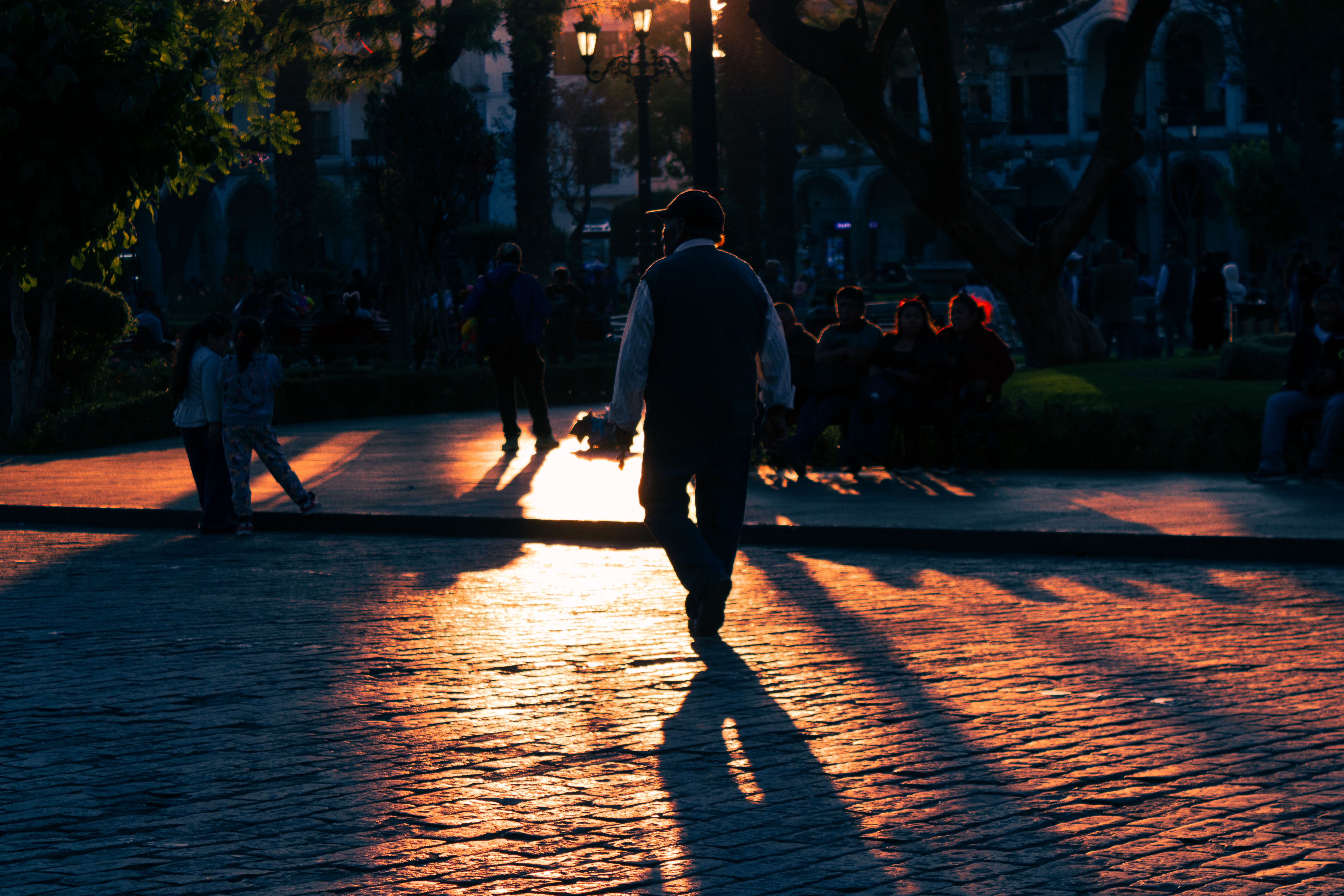 Man Walking During Golden Hour in Arequipa Plaza · Free Stock Photo
