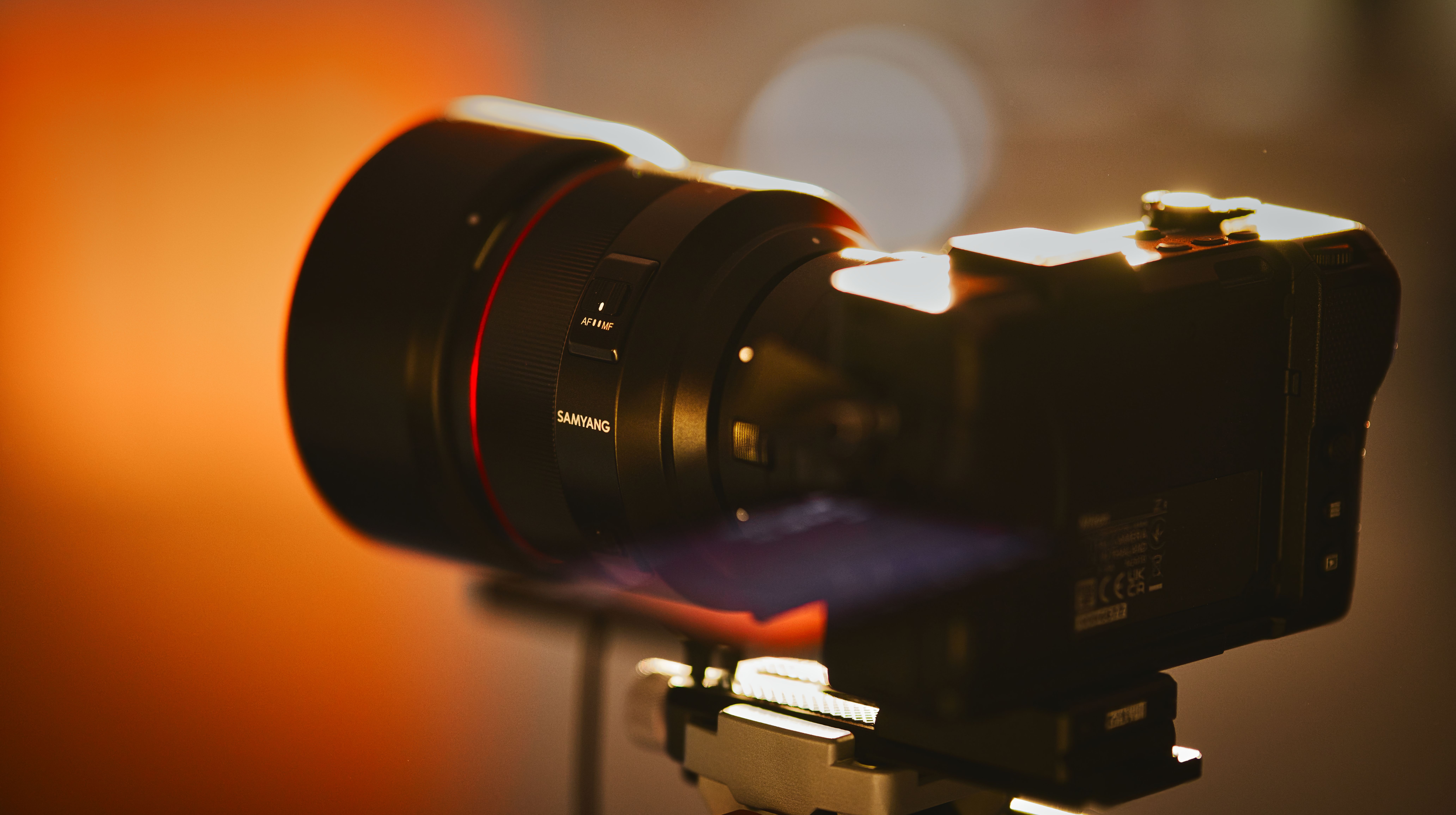 Close-up of Camera Lens with Warm Lighting · Free Stock Photo