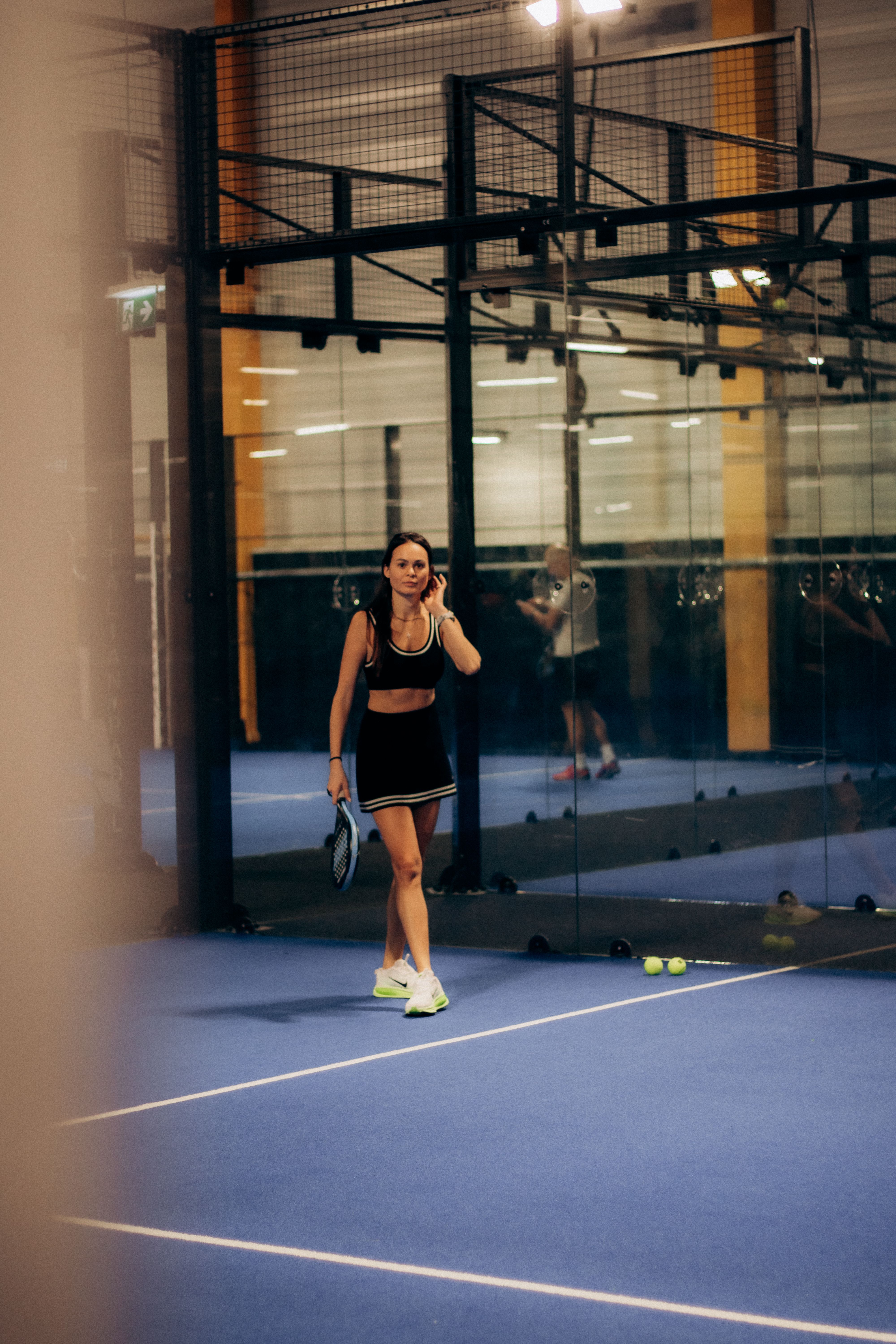 Indoor Tennis Player Reflects by Glass Wall · Free Stock Photo