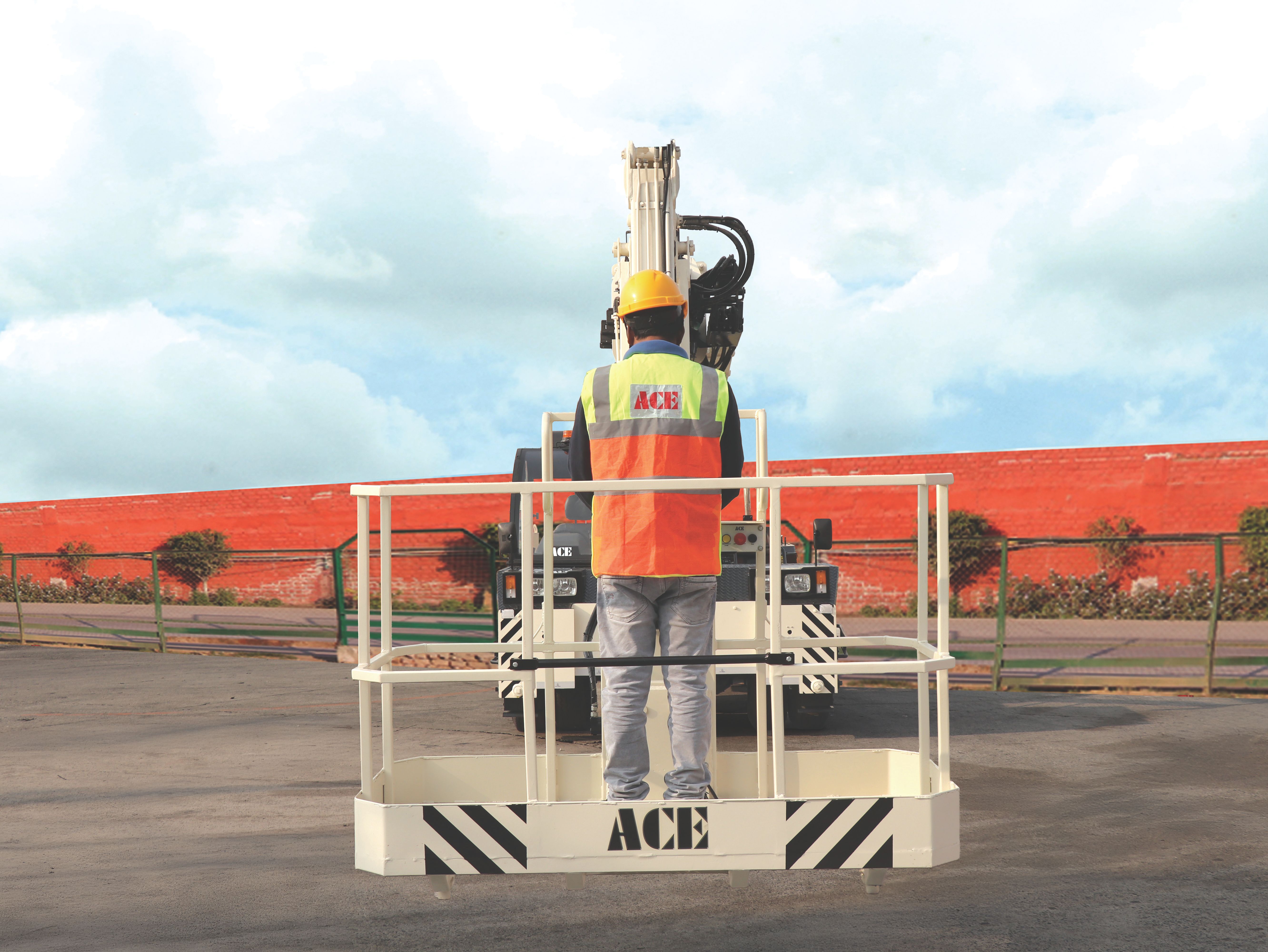 Industrial Worker Operating ACE Man Lift Crane Outdoors · Free Stock Photo