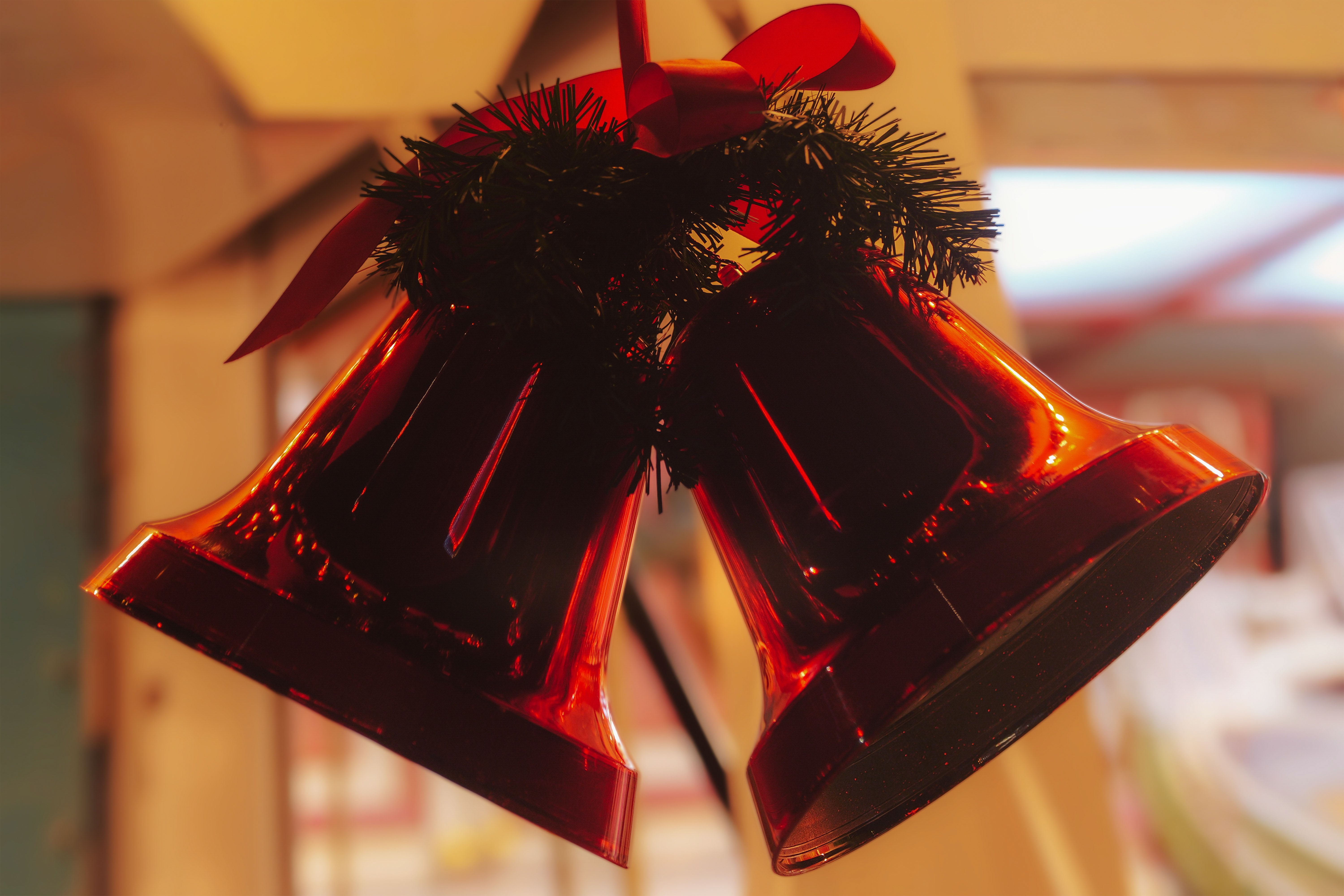 Vibrant Red Christmas Bells with Greenery · Free Stock Photo