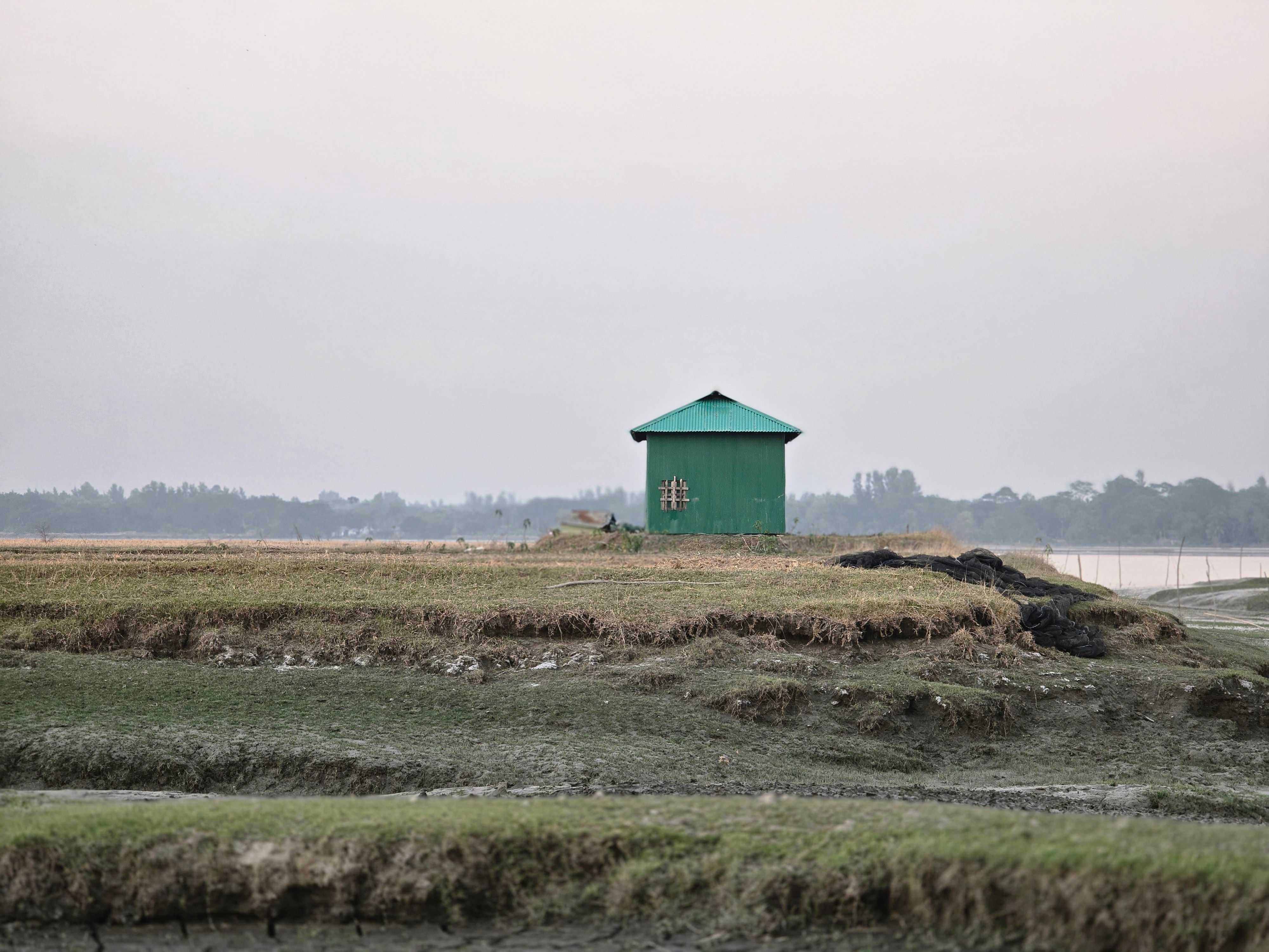 Isolated Green Hut on Riverside Landscape in Winter · Free Stock Photo