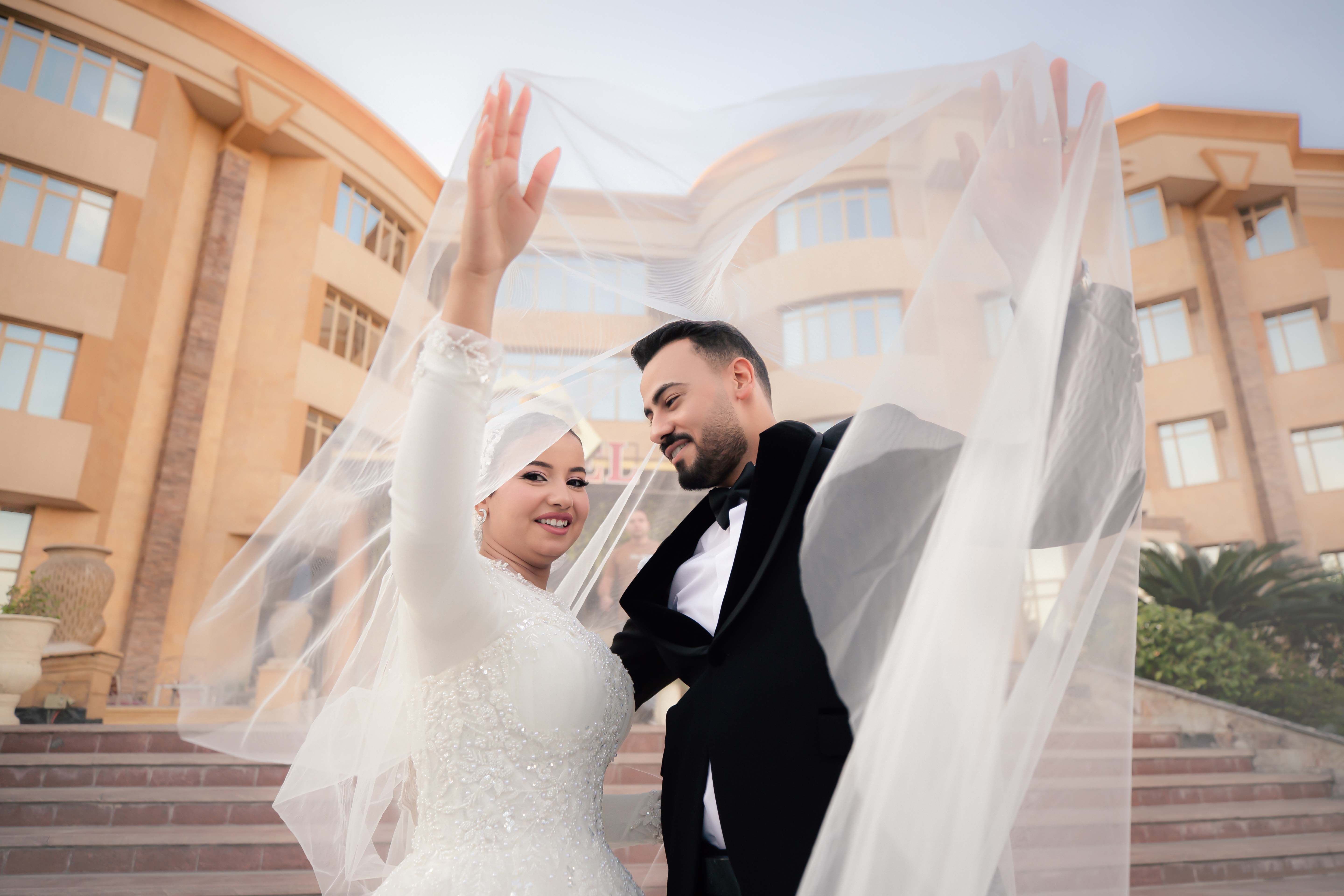Elegant Outdoor Wedding Portrait at Building Backdrop · Free Stock Photo