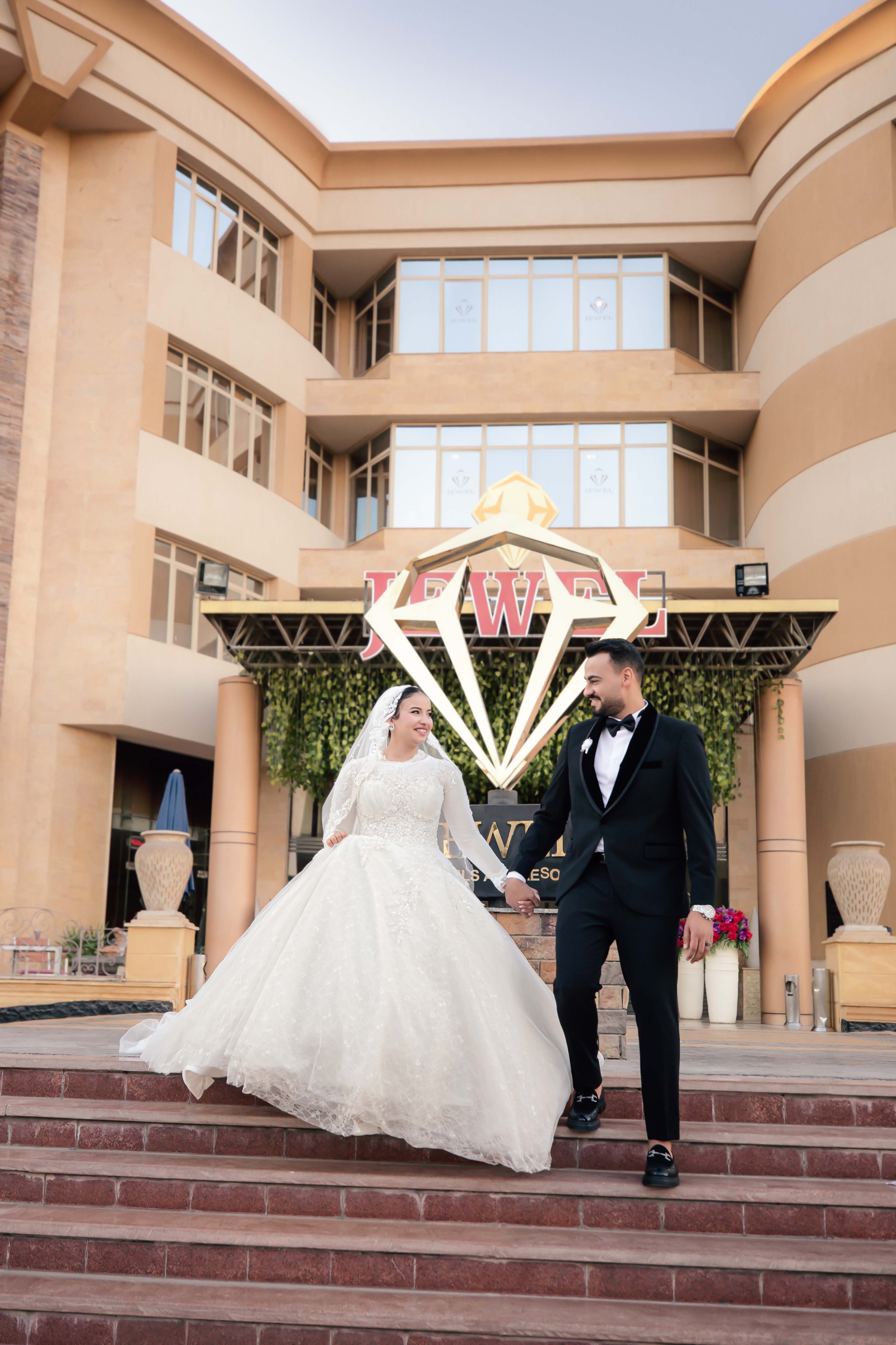 Elegant Wedding Couple in Front of Modern Building · Free Stock Photo