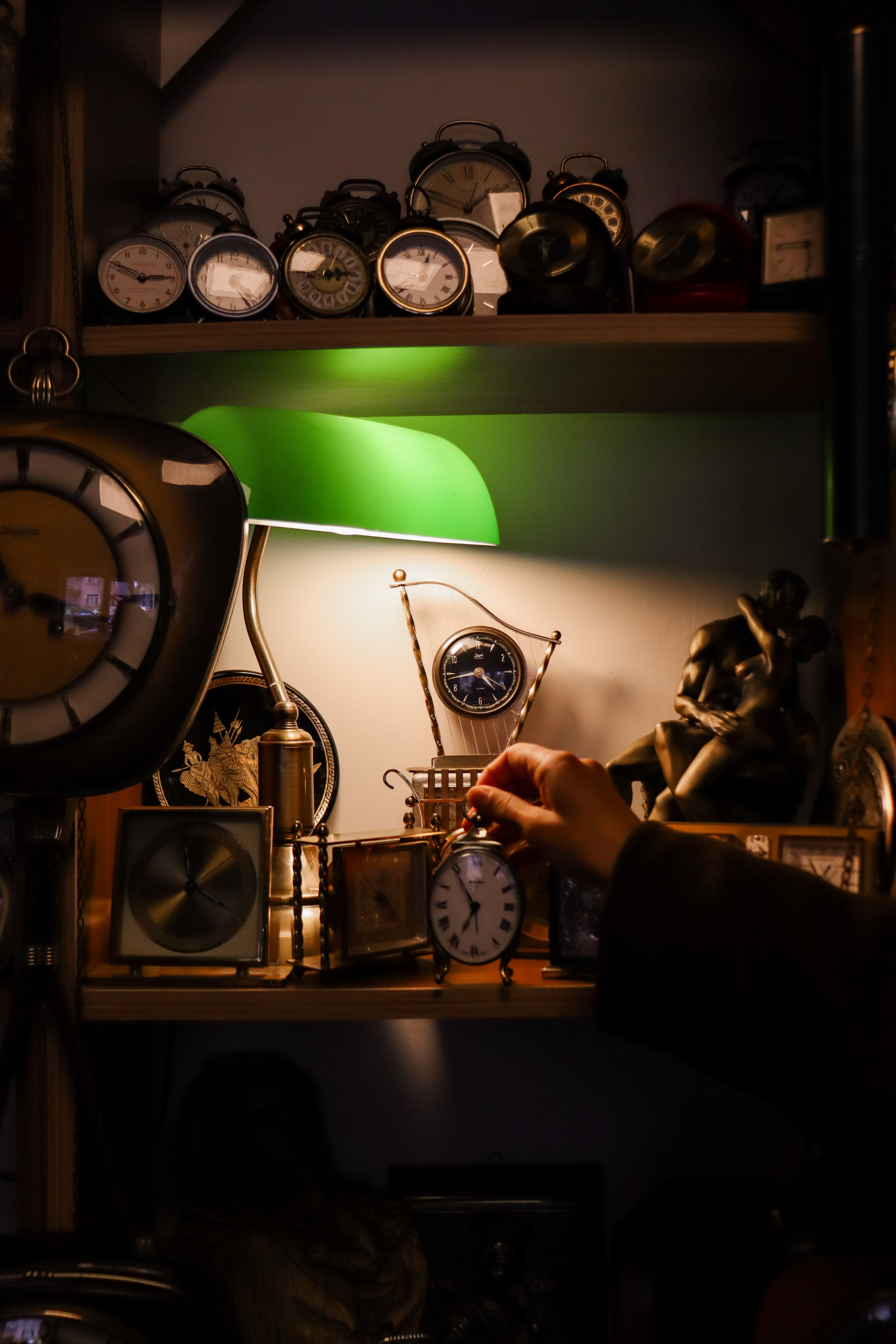 Vintage Clocks on Shelf with Dim Lighting · Free Stock Photo