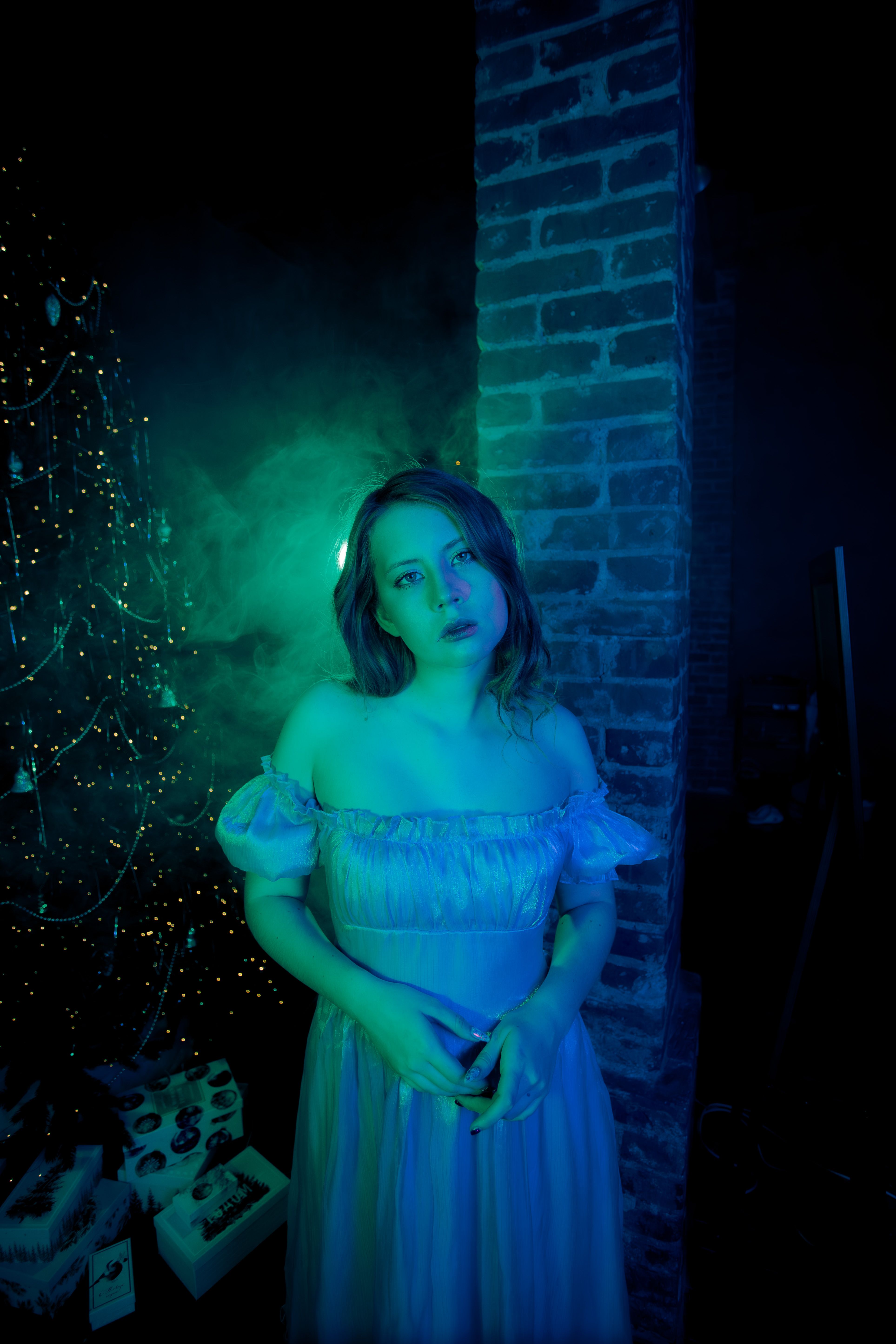 Ethereal Woman by Christmas Tree in Dim Light · Free Stock Photo