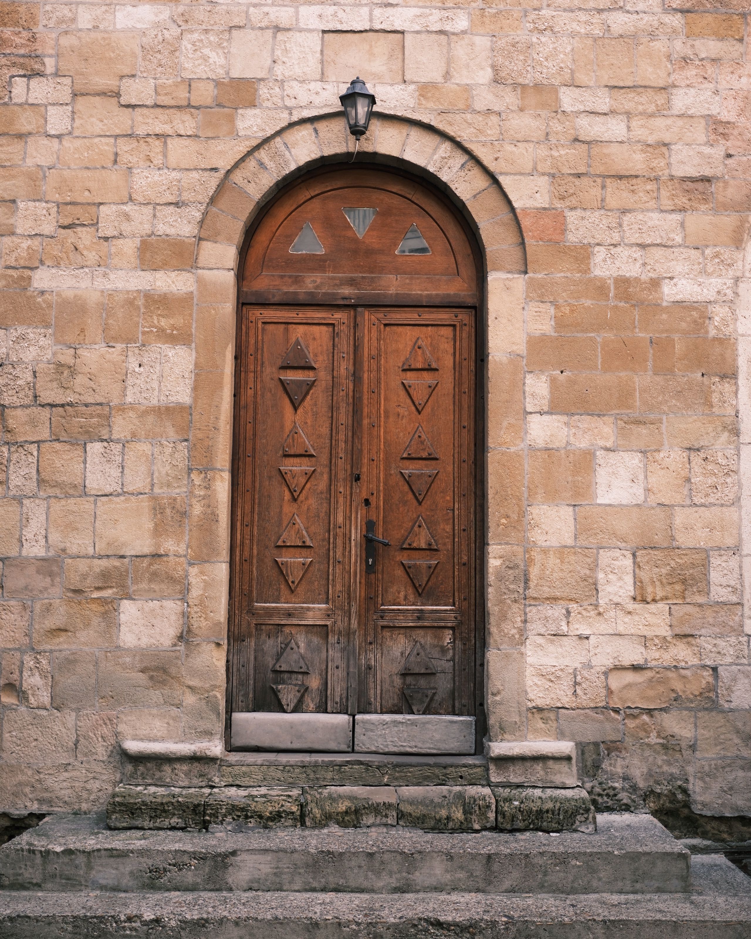 Rustic Wooden Door in Ancient Stone Wall · Free Stock Photo