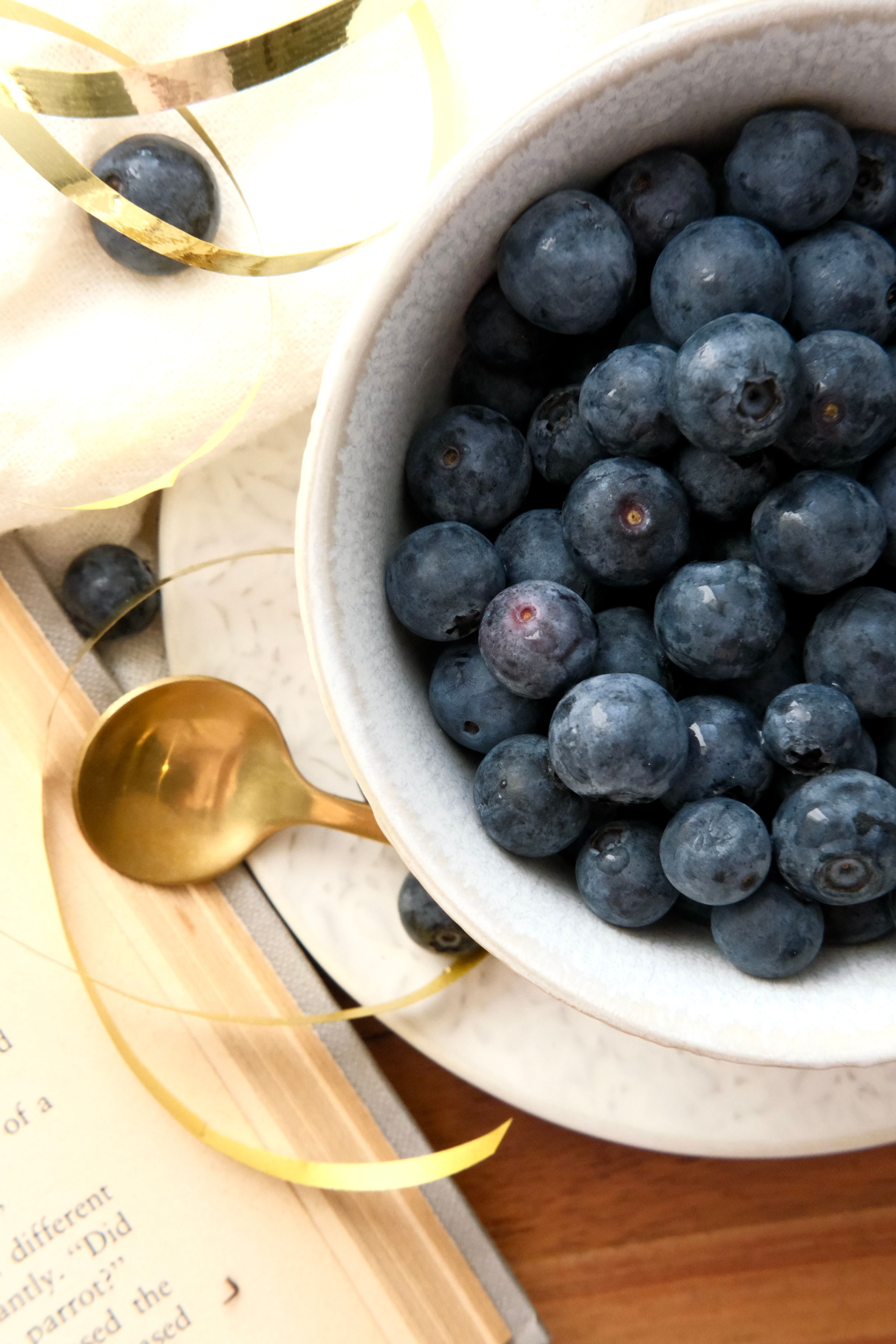 Fresh Blueberries in a Bowl with Golden Spoon · Free Stock Photo